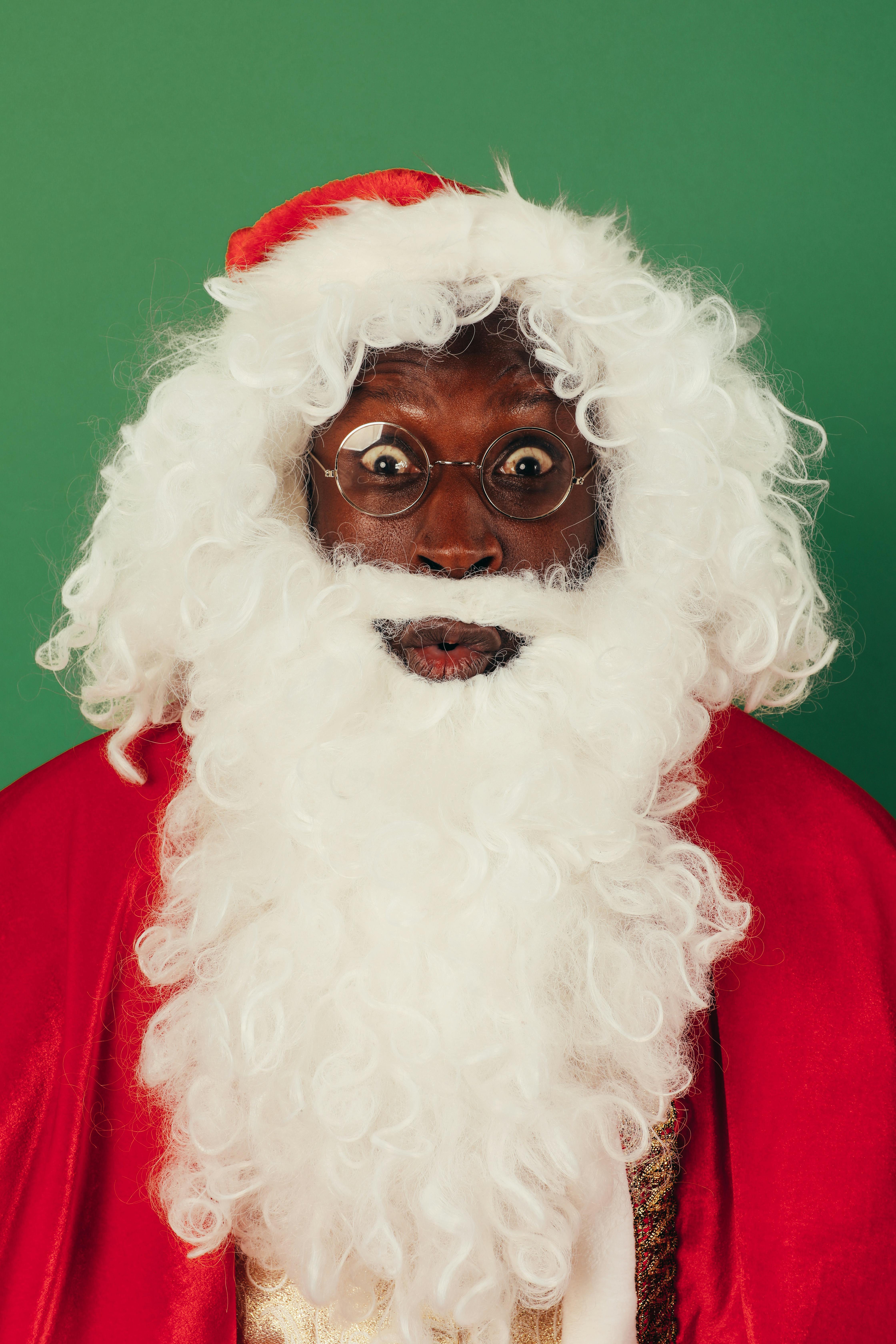 Person Wearing A Santa Outfit With Gifts On His Lap · Free Stock Photo
