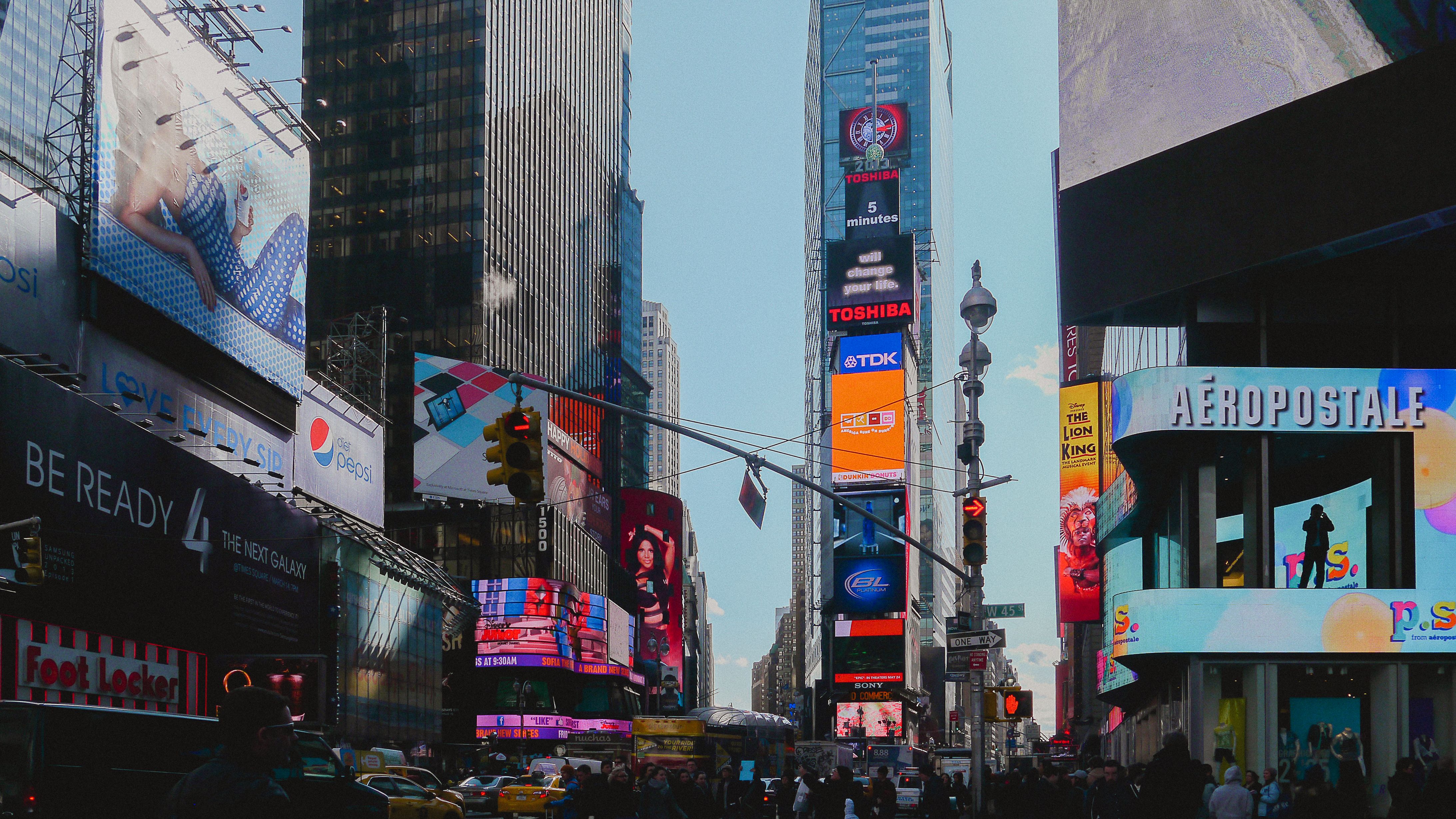 City Street with Shops Signs on Buildings · Free Stock Photo