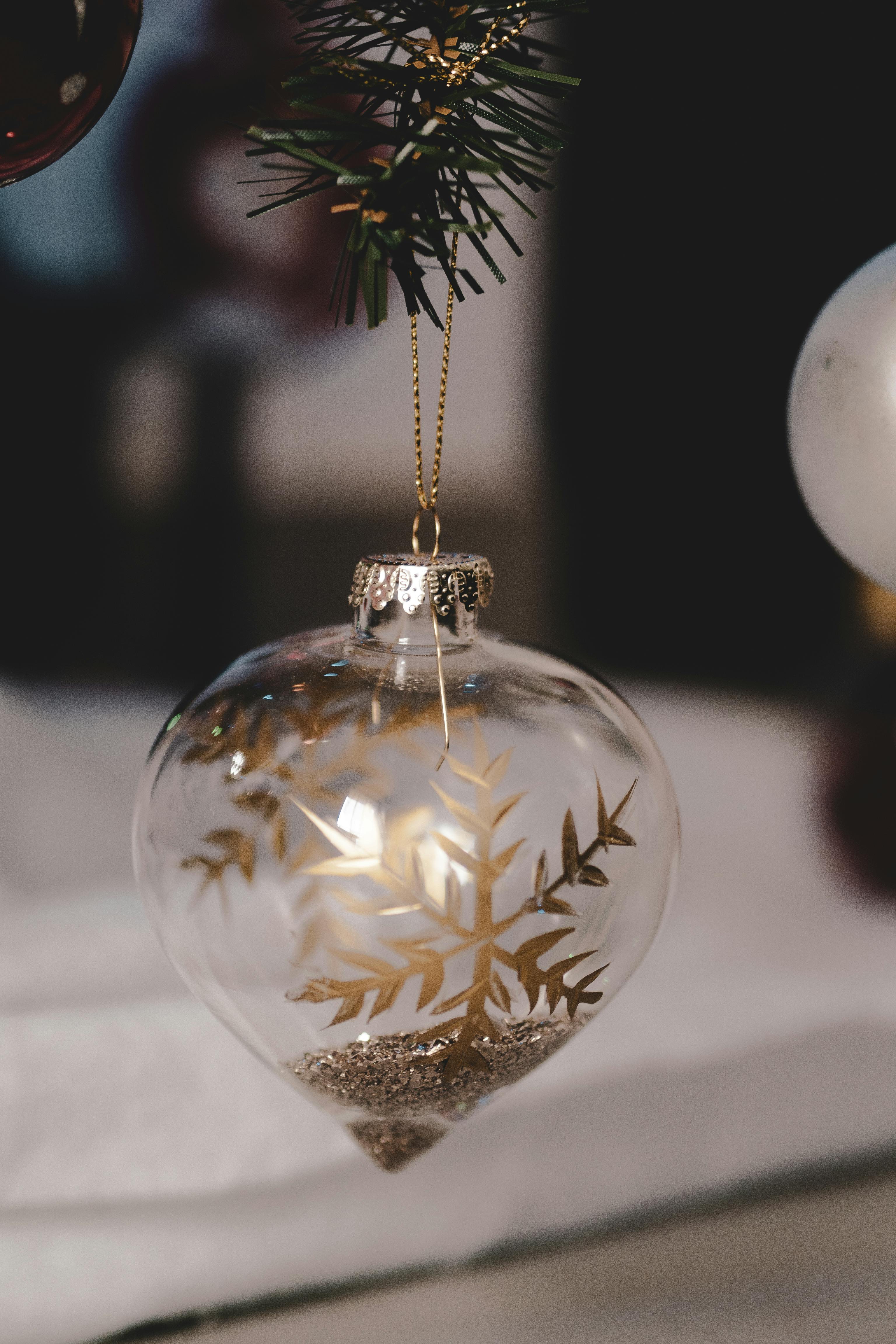 Red Christmas Bauble With Red Ribbon on Wooden Surface in Close Up ...