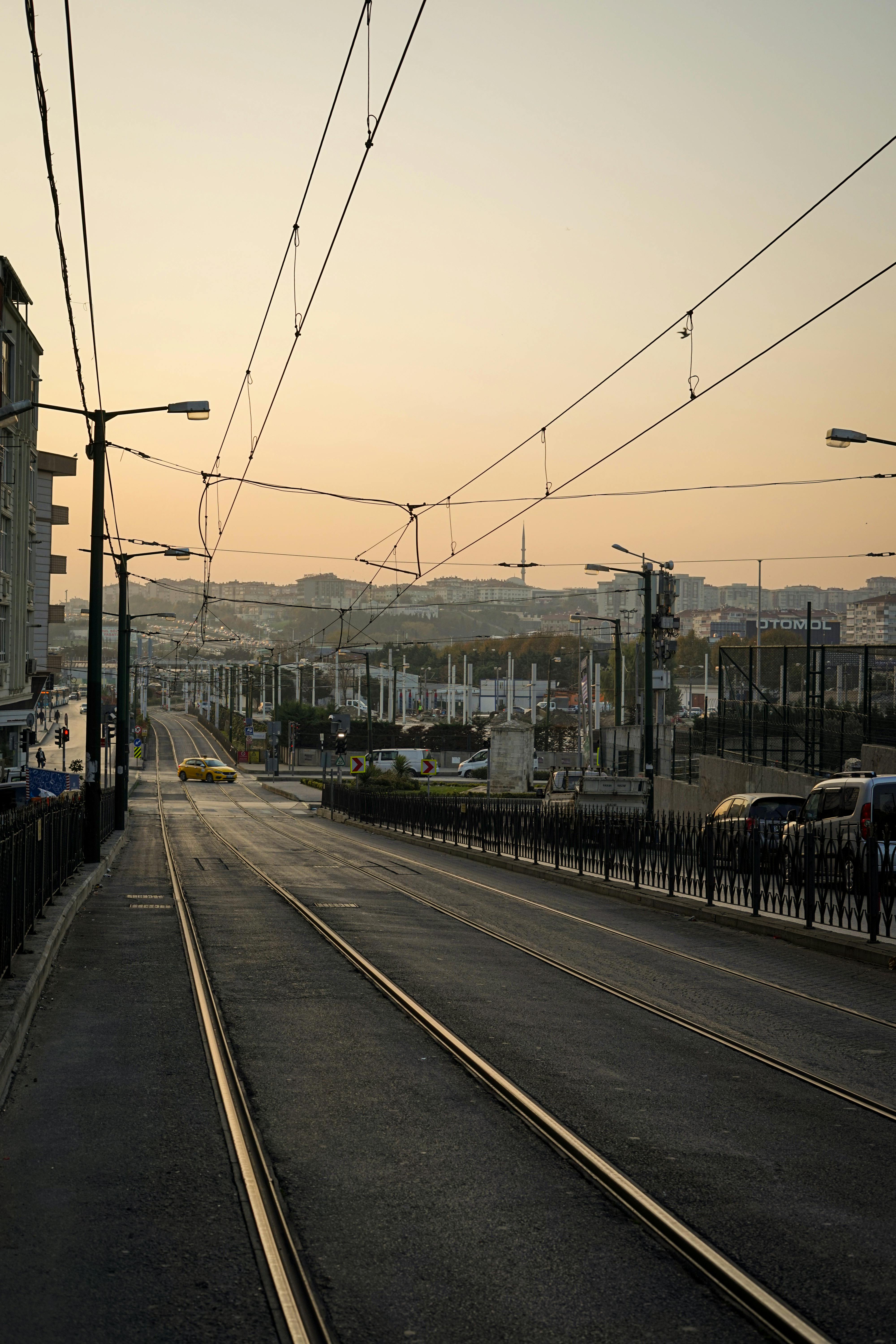A Tram in the Middle of the Road Near Buildings · Free Stock Photo