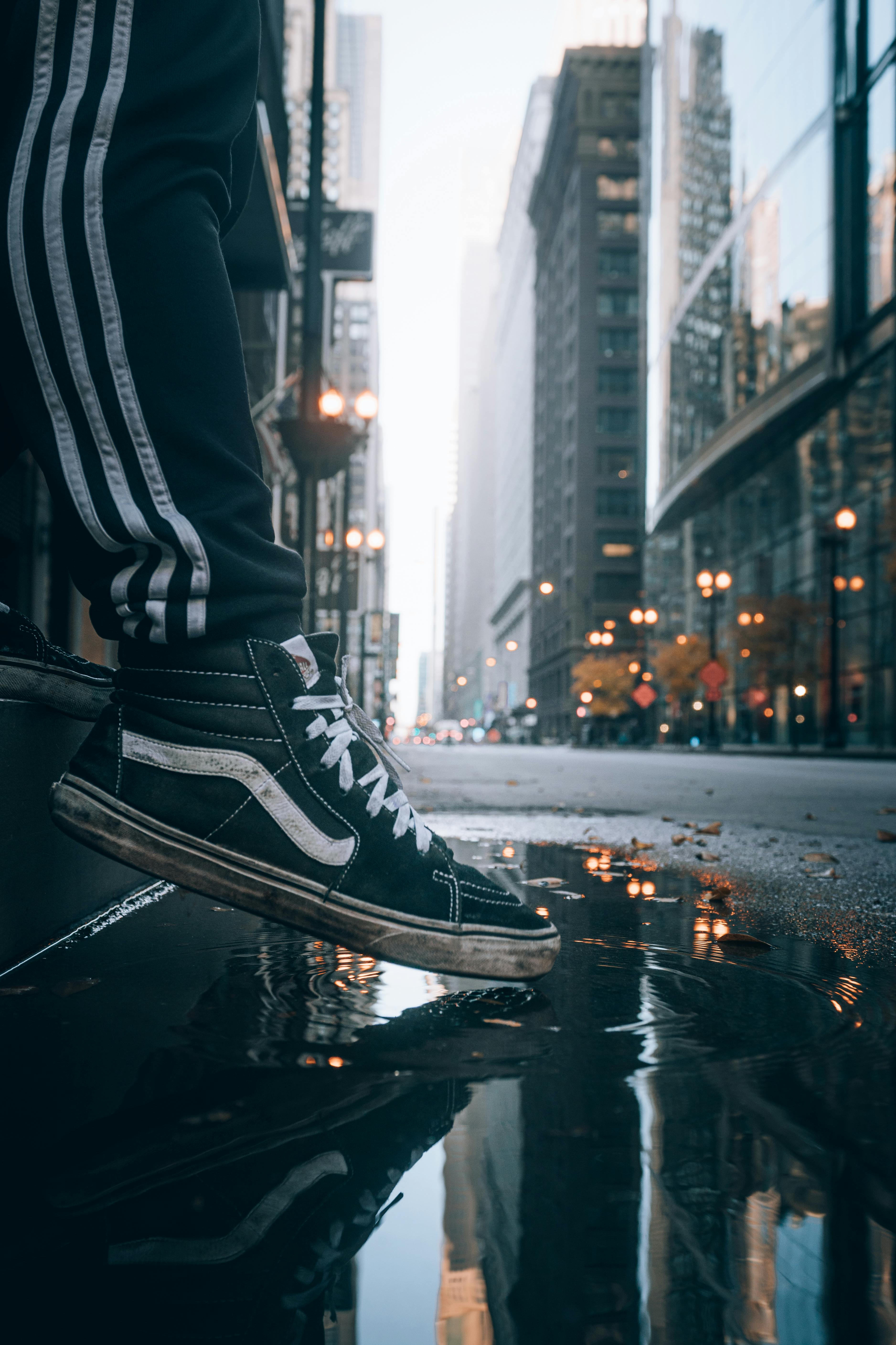 Man Stepping on Street Puddle · Free Stock Photo