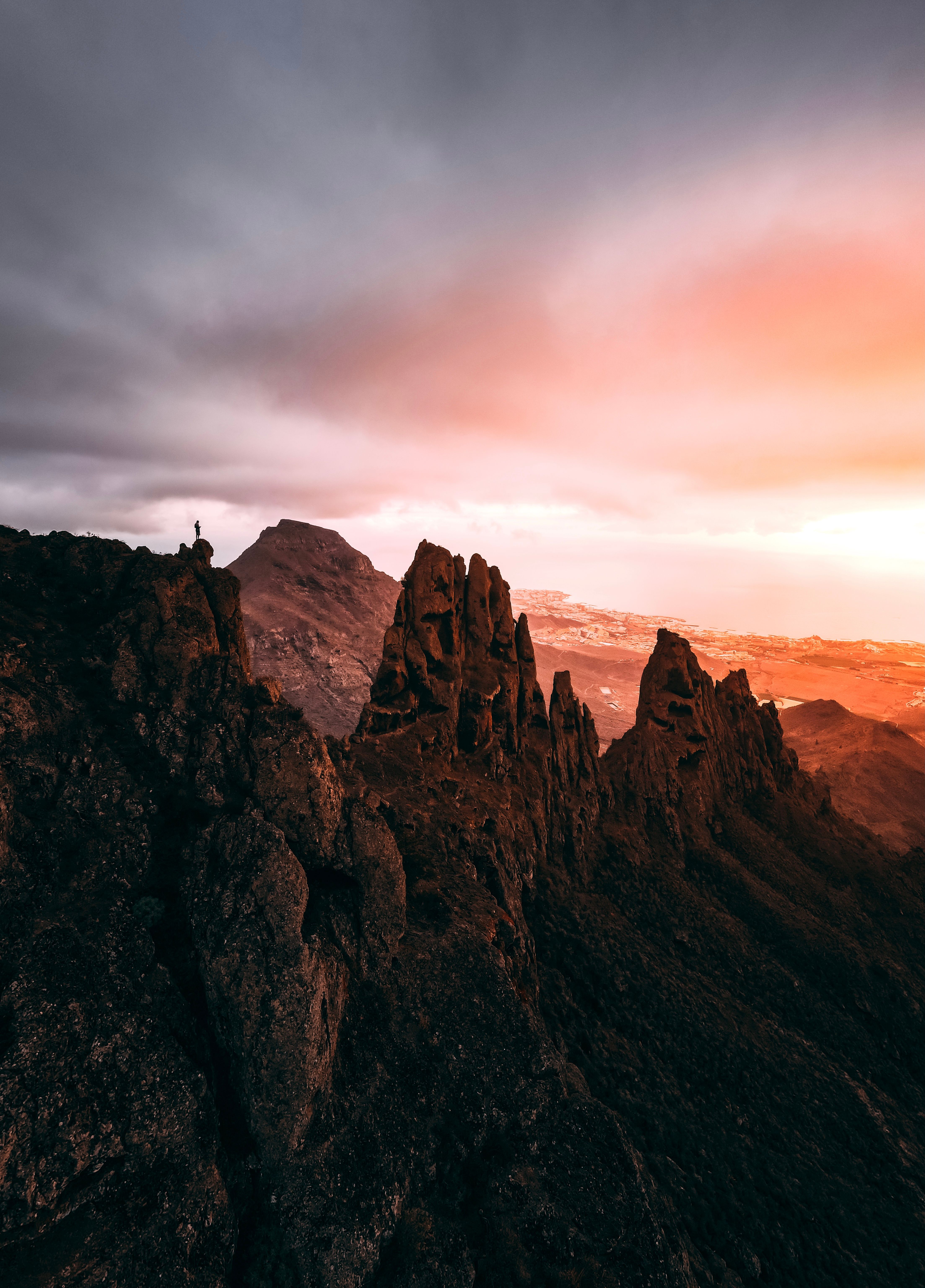 Endless mountain terrain under overcast sunset sky · Free Stock Photo