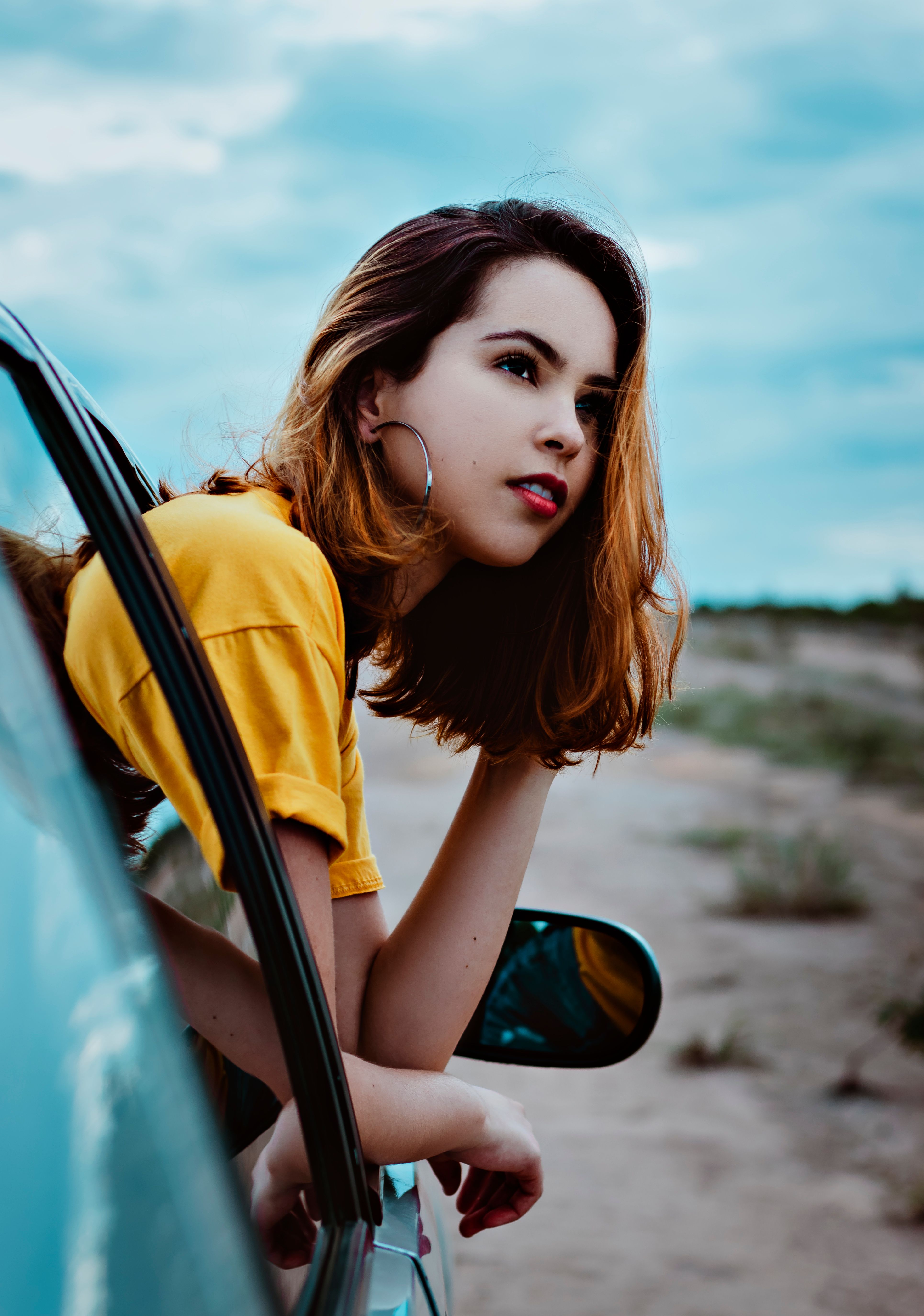 Woman inside a Car Waving Goodbye · Free Stock Photo