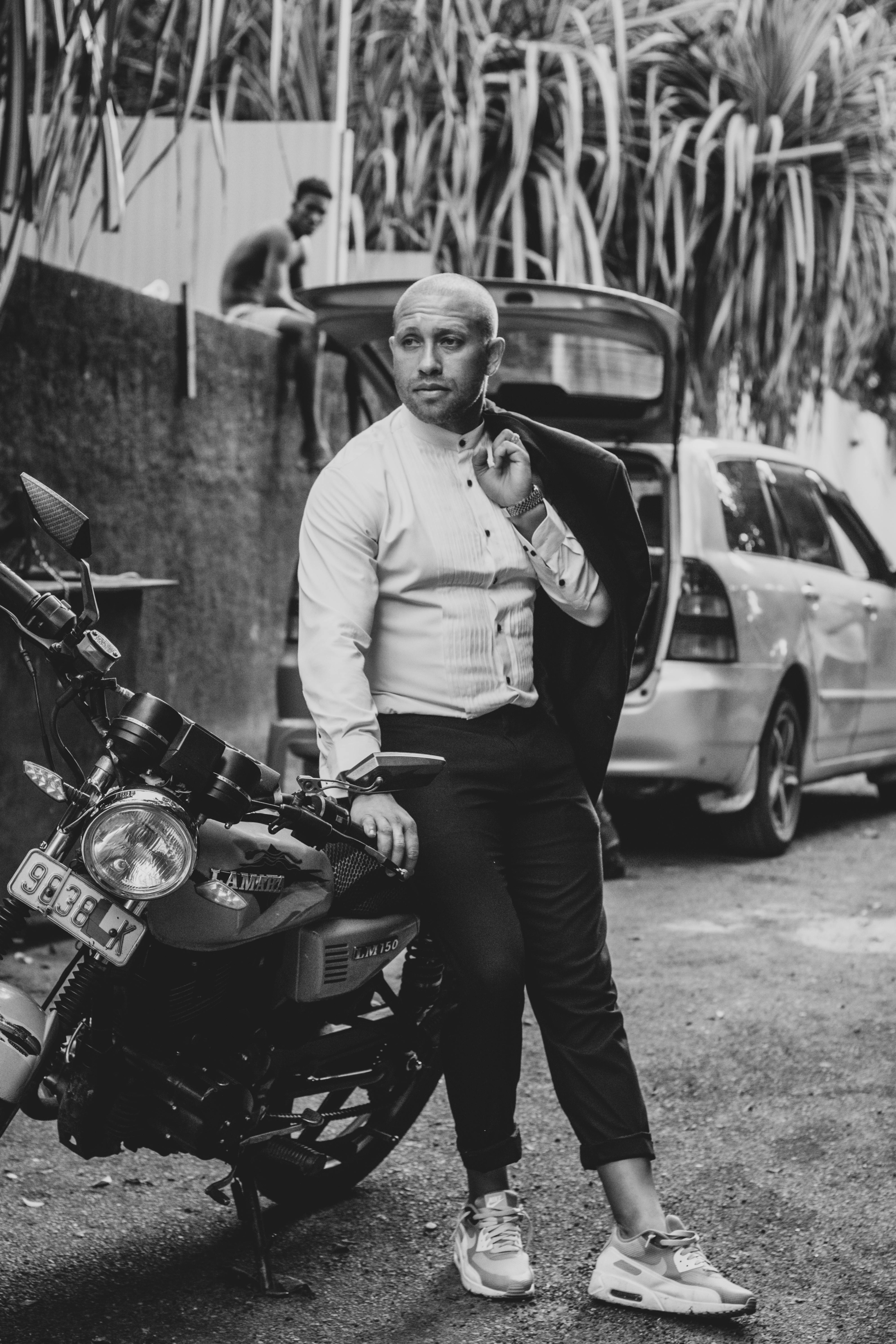 Bald Man Standing by a Motorcycle · Free Stock Photo