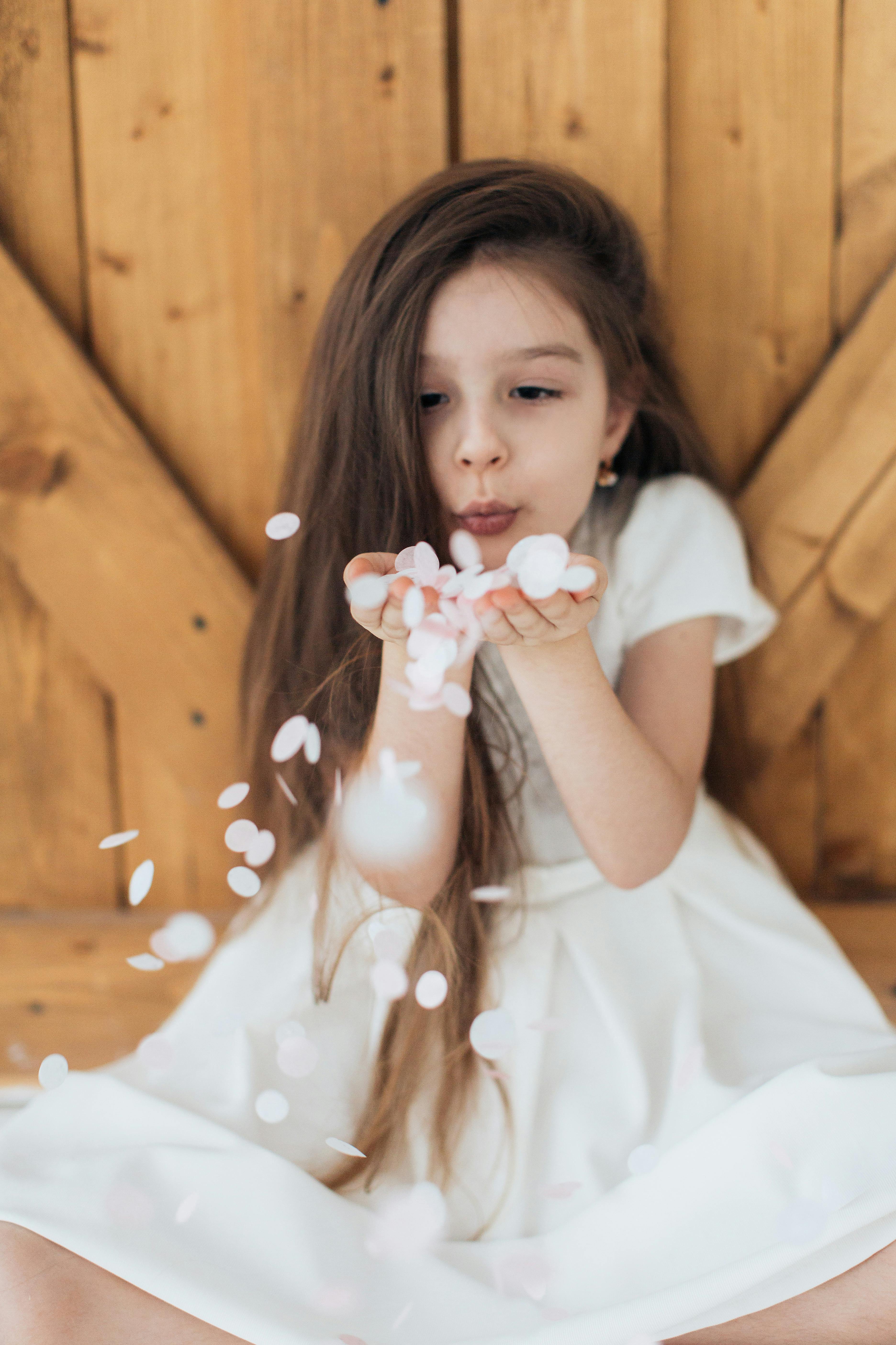 Girl Blowing Flower Petals · Free Stock Photo
