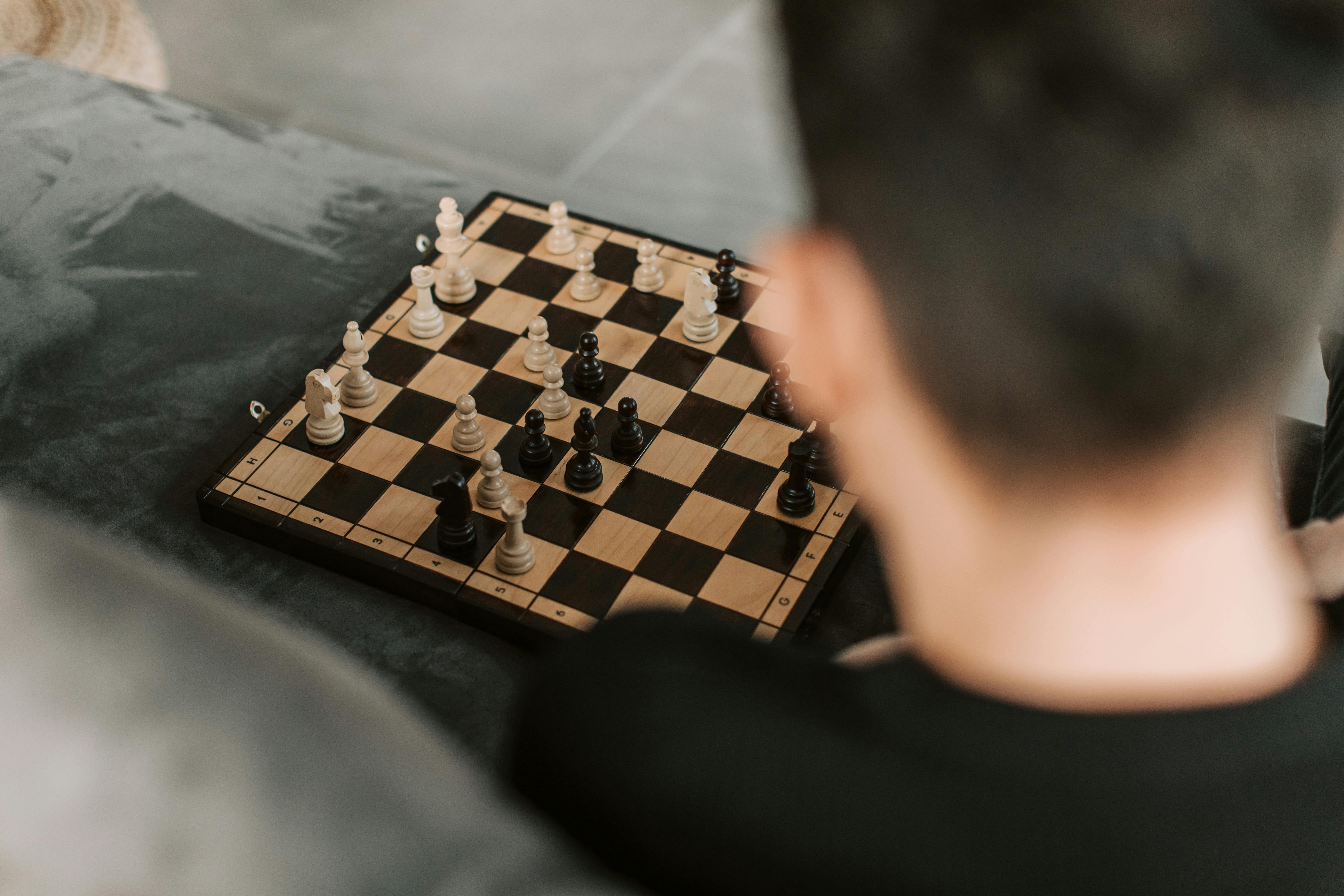 Back View of Man Playing Chess · Free Stock Photo