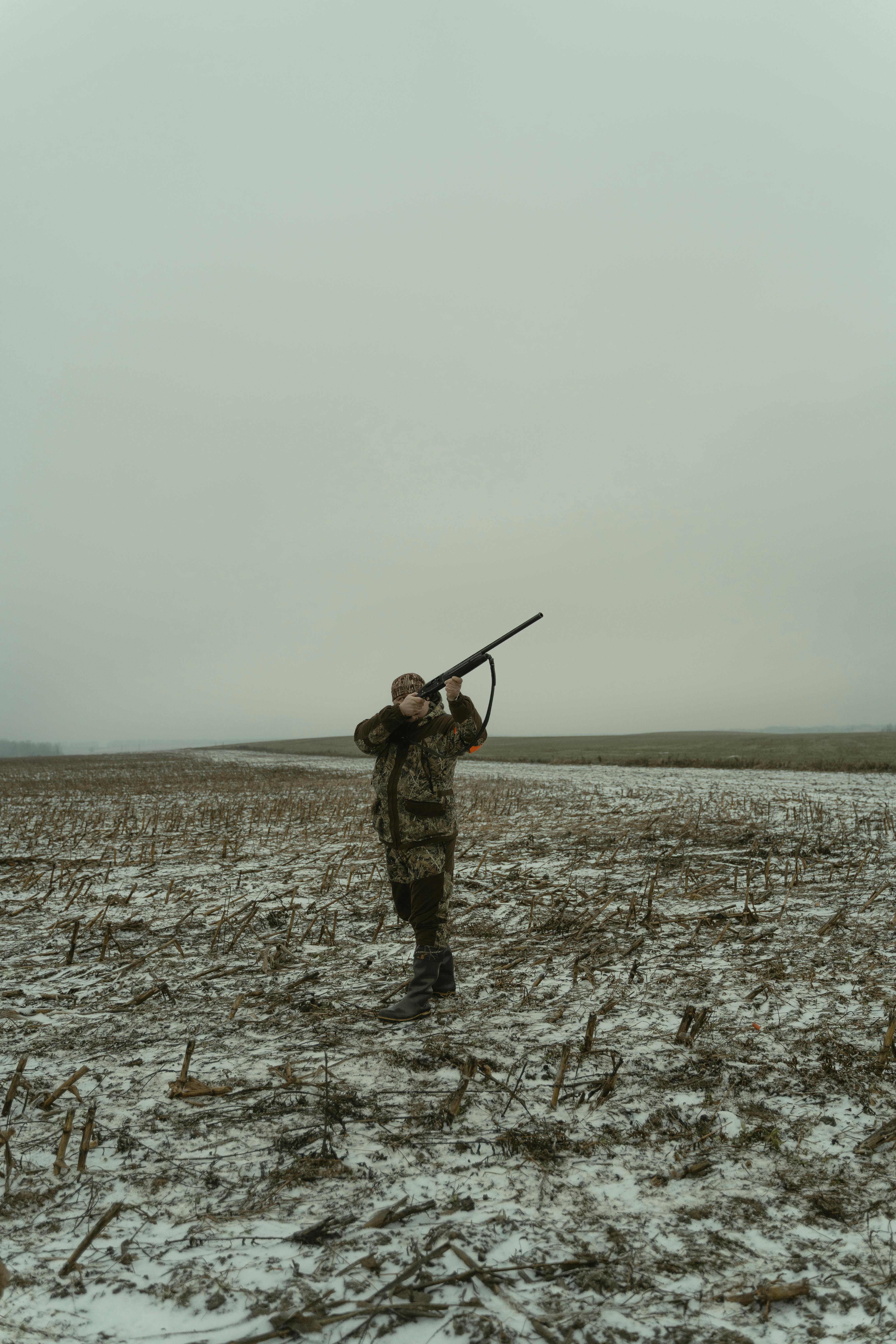 Man Standing While Aiming Rifle · Free Stock Photo