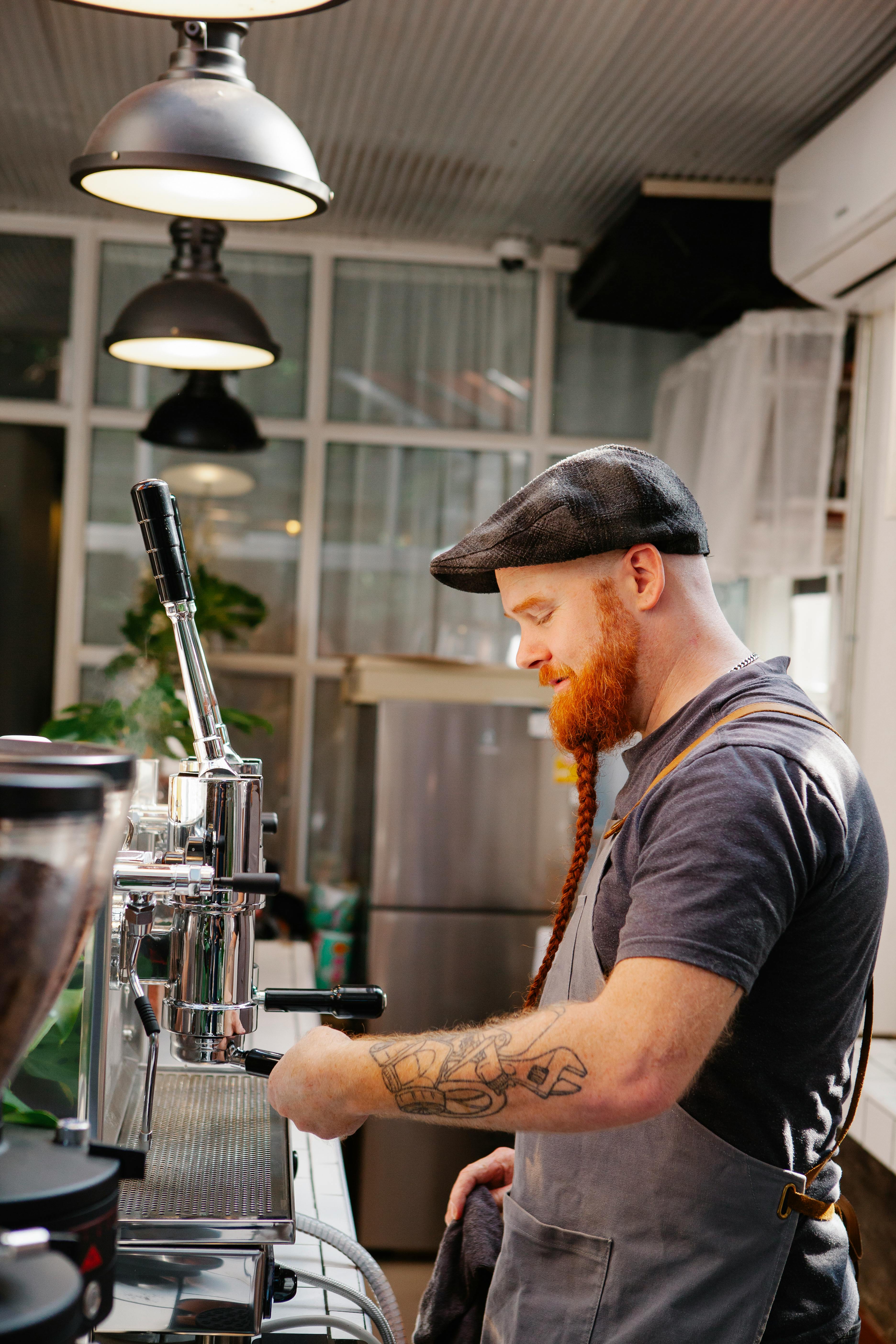 Crop coffee house worker making coffee using coffee machine · Free ...