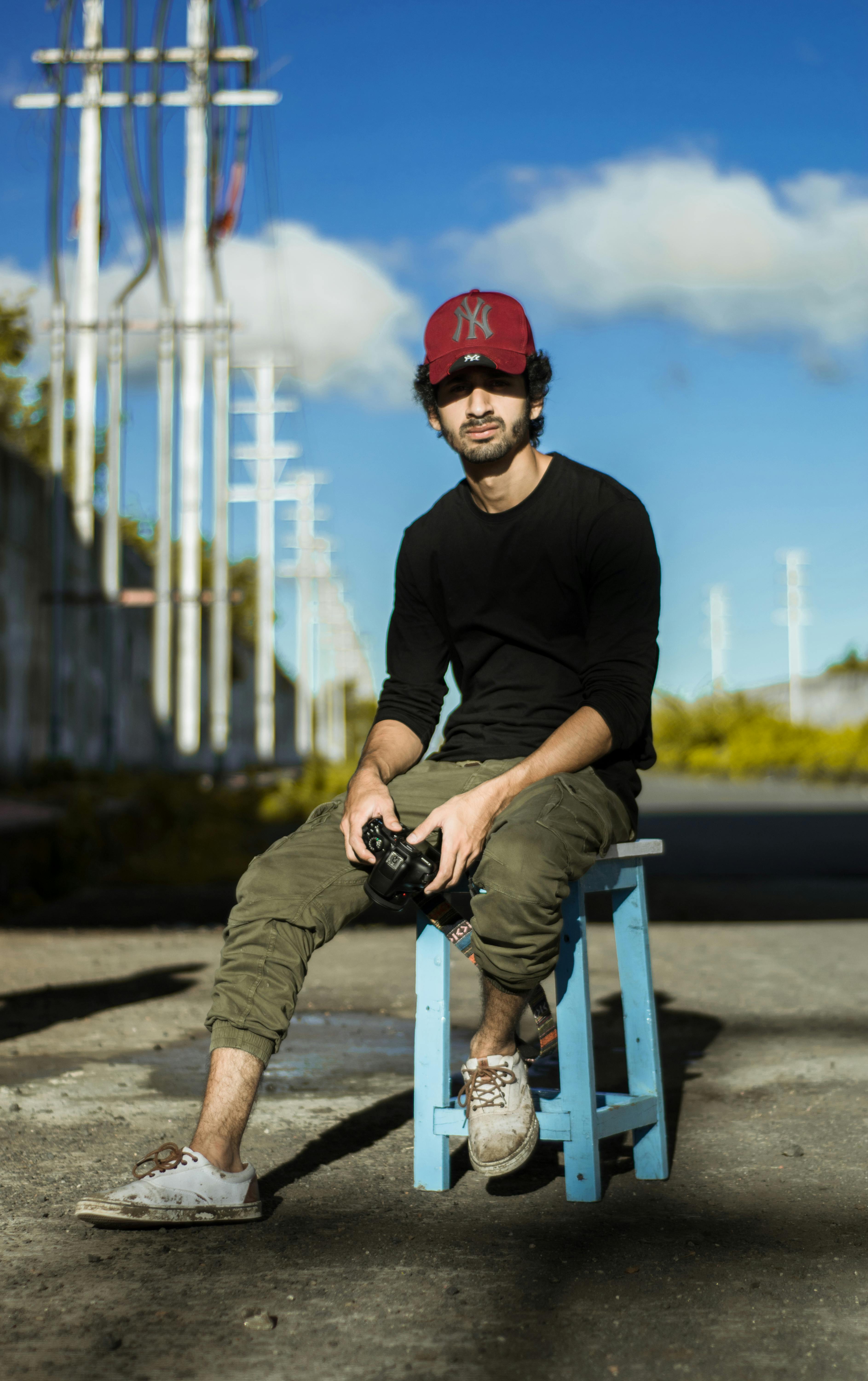 Photo of a Man Sitting on Stool · Free Stock Photo