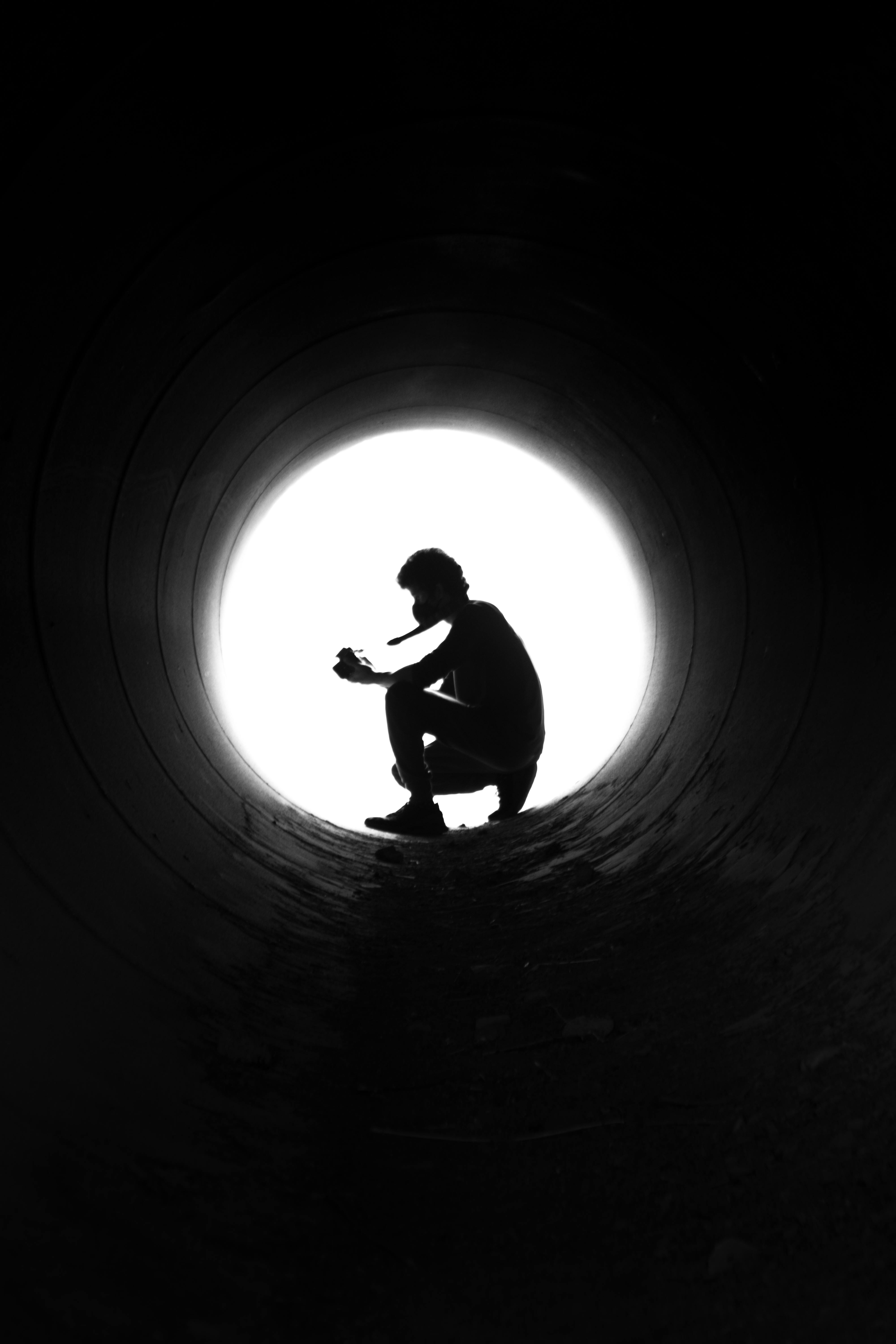 People Riding Canoe Boat View from Inside Pipe · Free Stock Photo