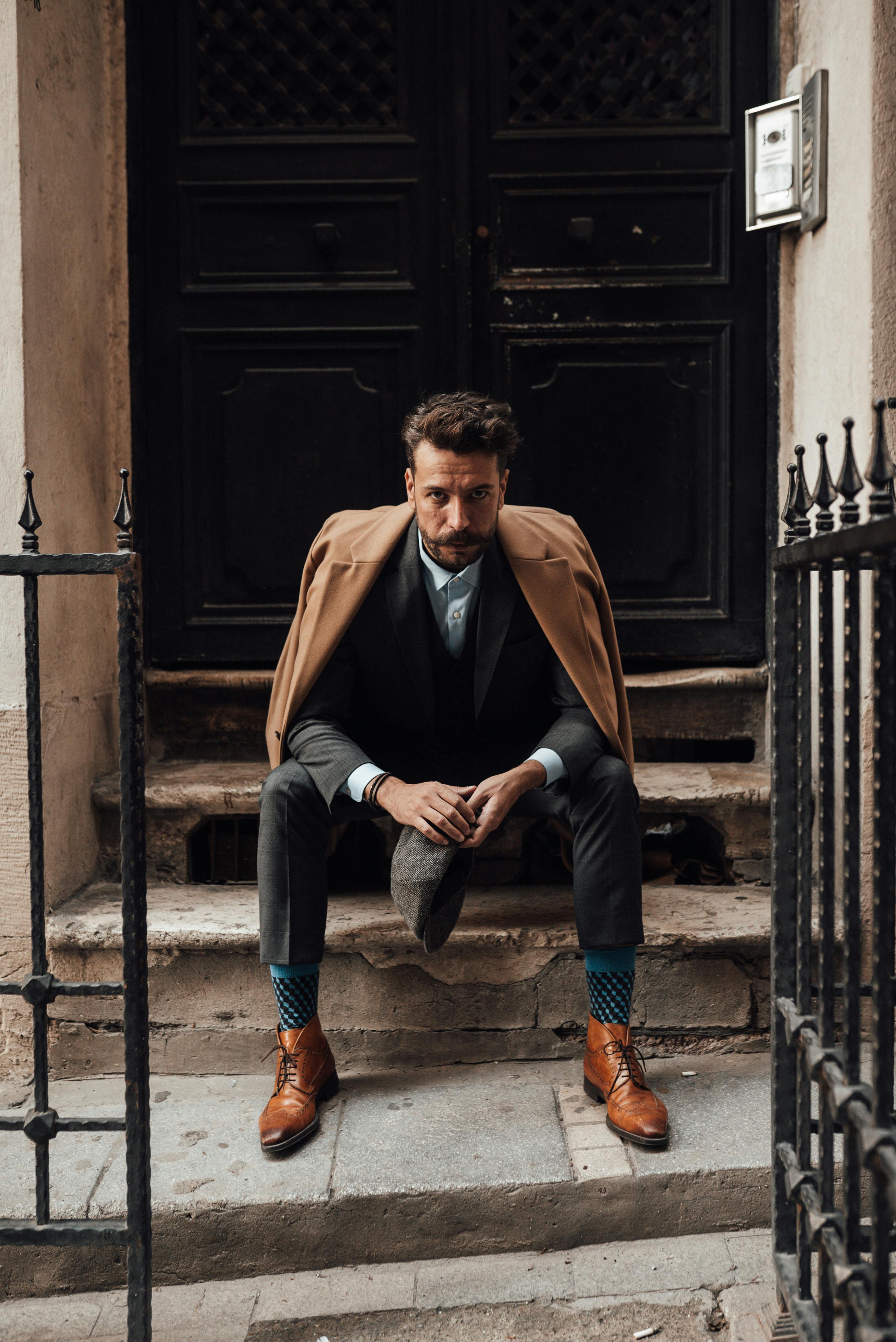 Confident man in stylish suit sitting on stairs of building · Free ...