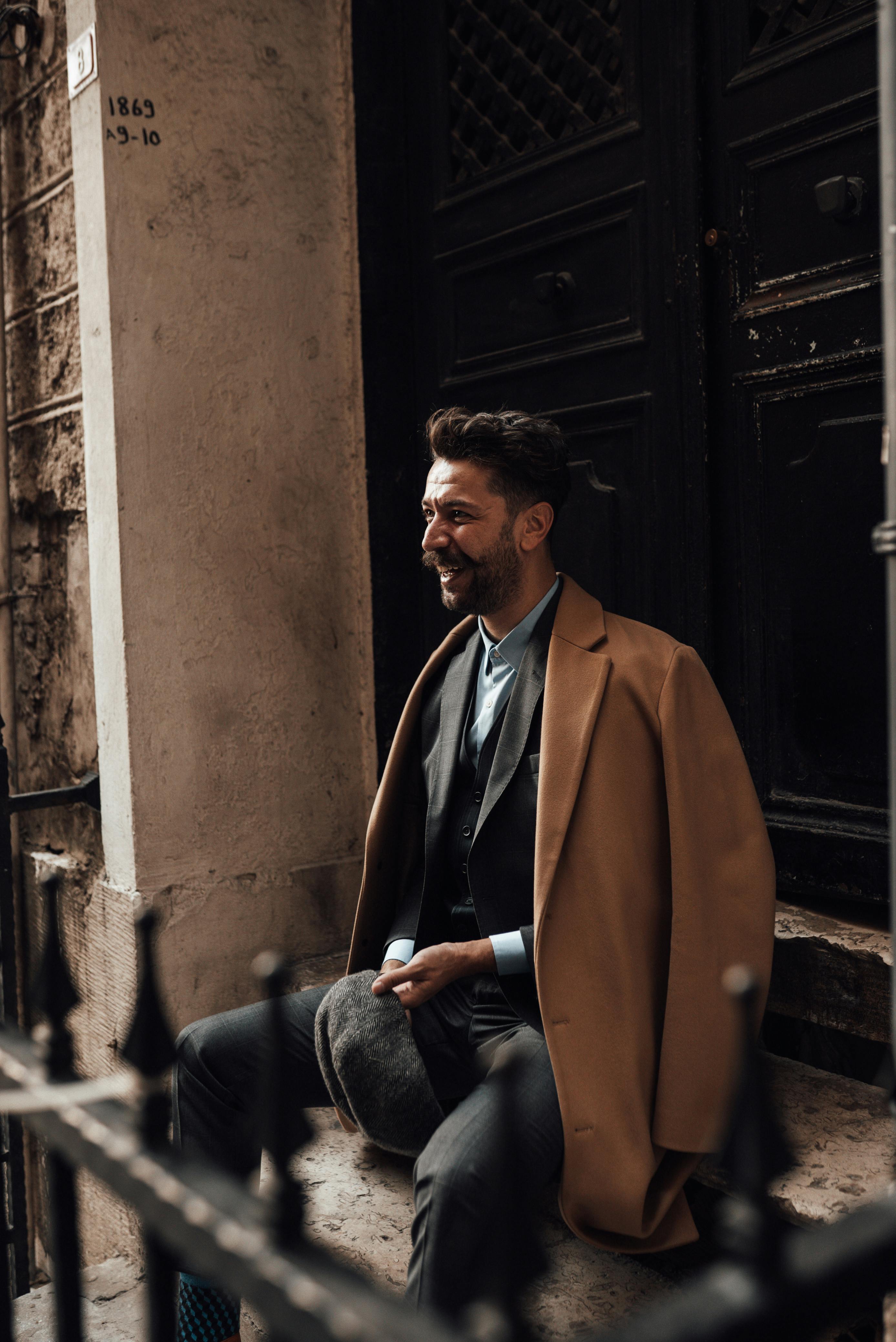 Thoughtful man entering building with huge door · Free Stock Photo