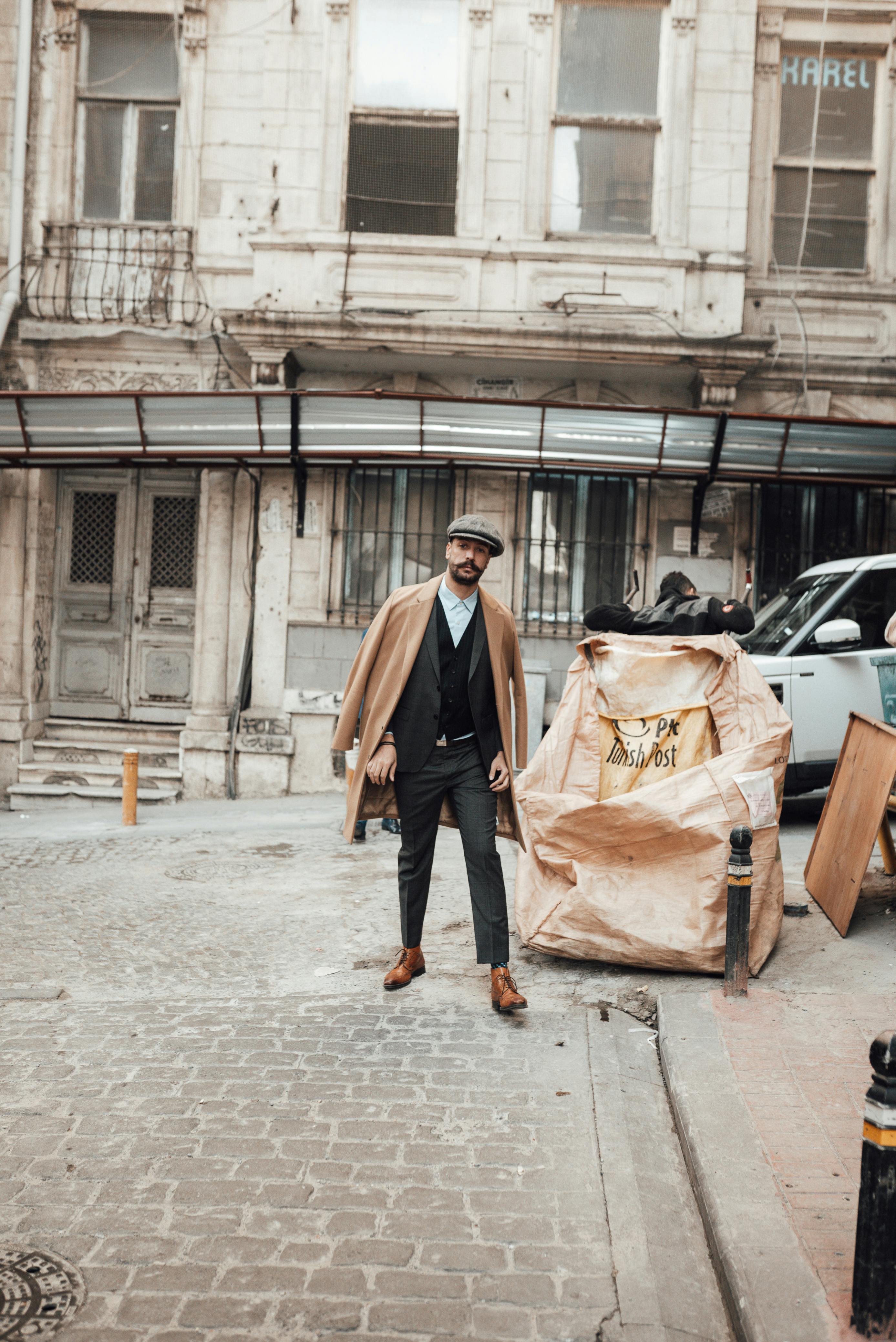Thoughtful man entering building with huge door · Free Stock Photo