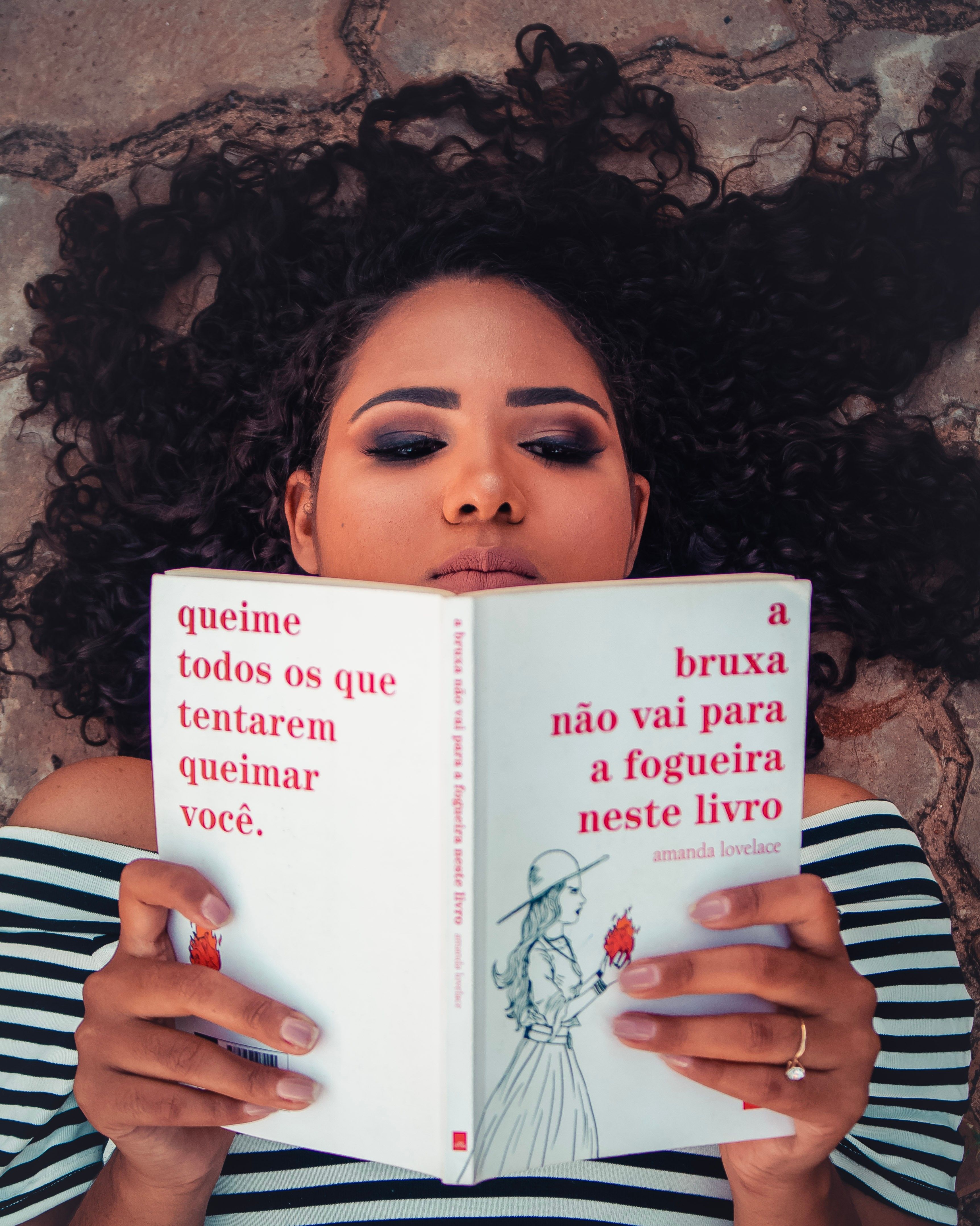 Back View of a Woman Reading a Book · Free Stock Photo