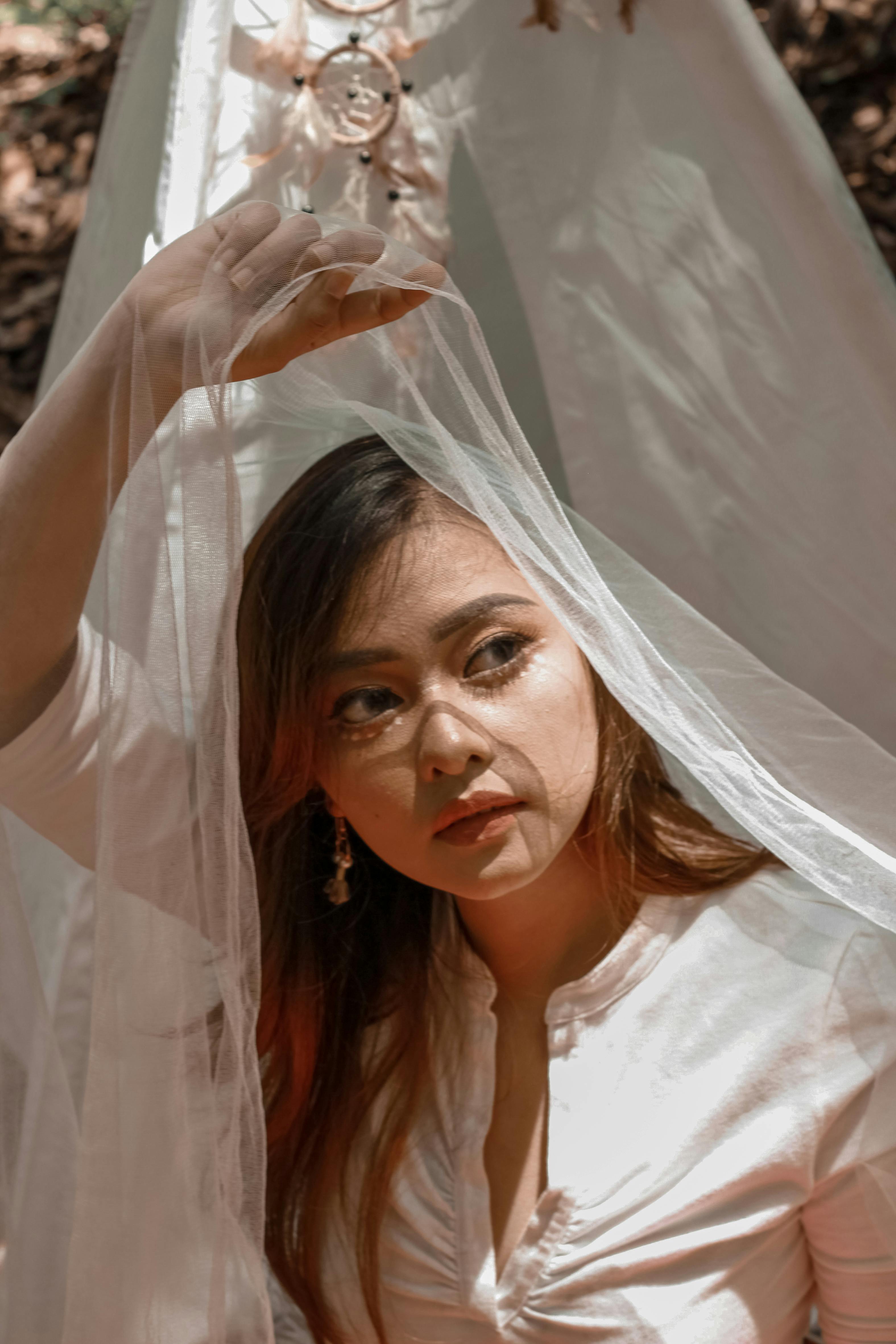 Woman in White Dress Holding White Sheer Fabric · Free Stock Photo
