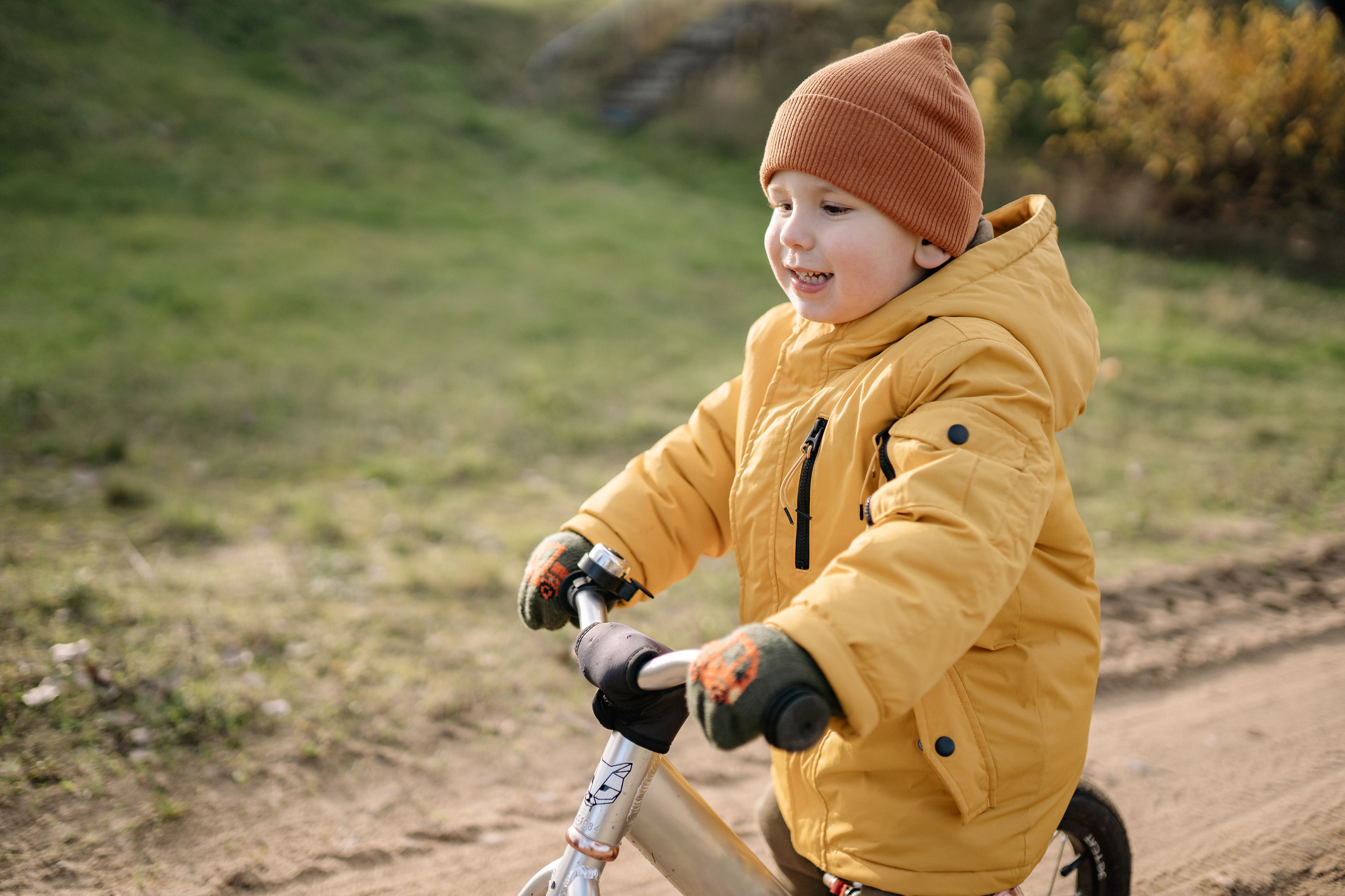 A Back View of a Child Riding a Bicycle · Free Stock Photo