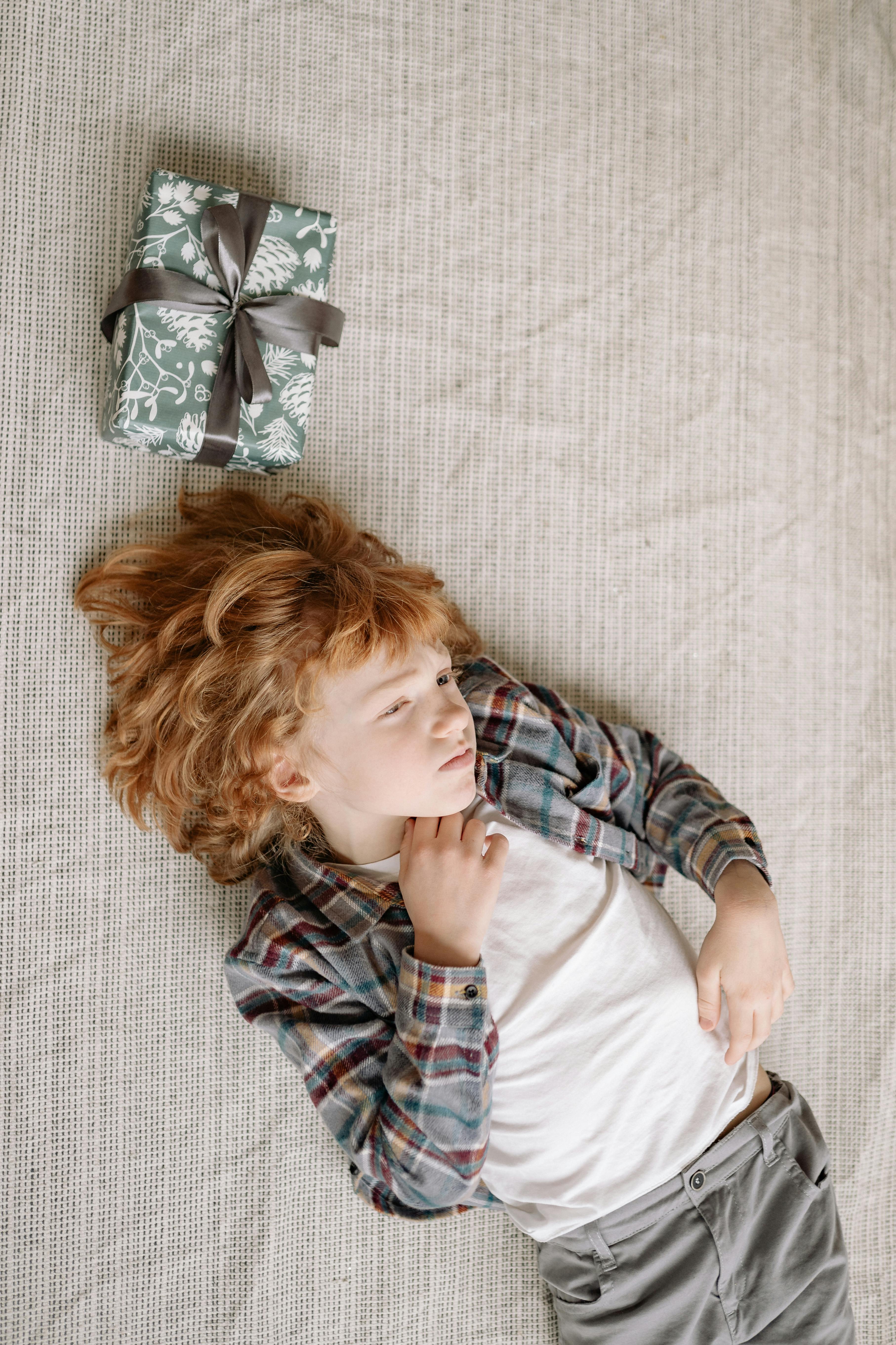 Kids Lying on the Carpet Floor · Free Stock Photo