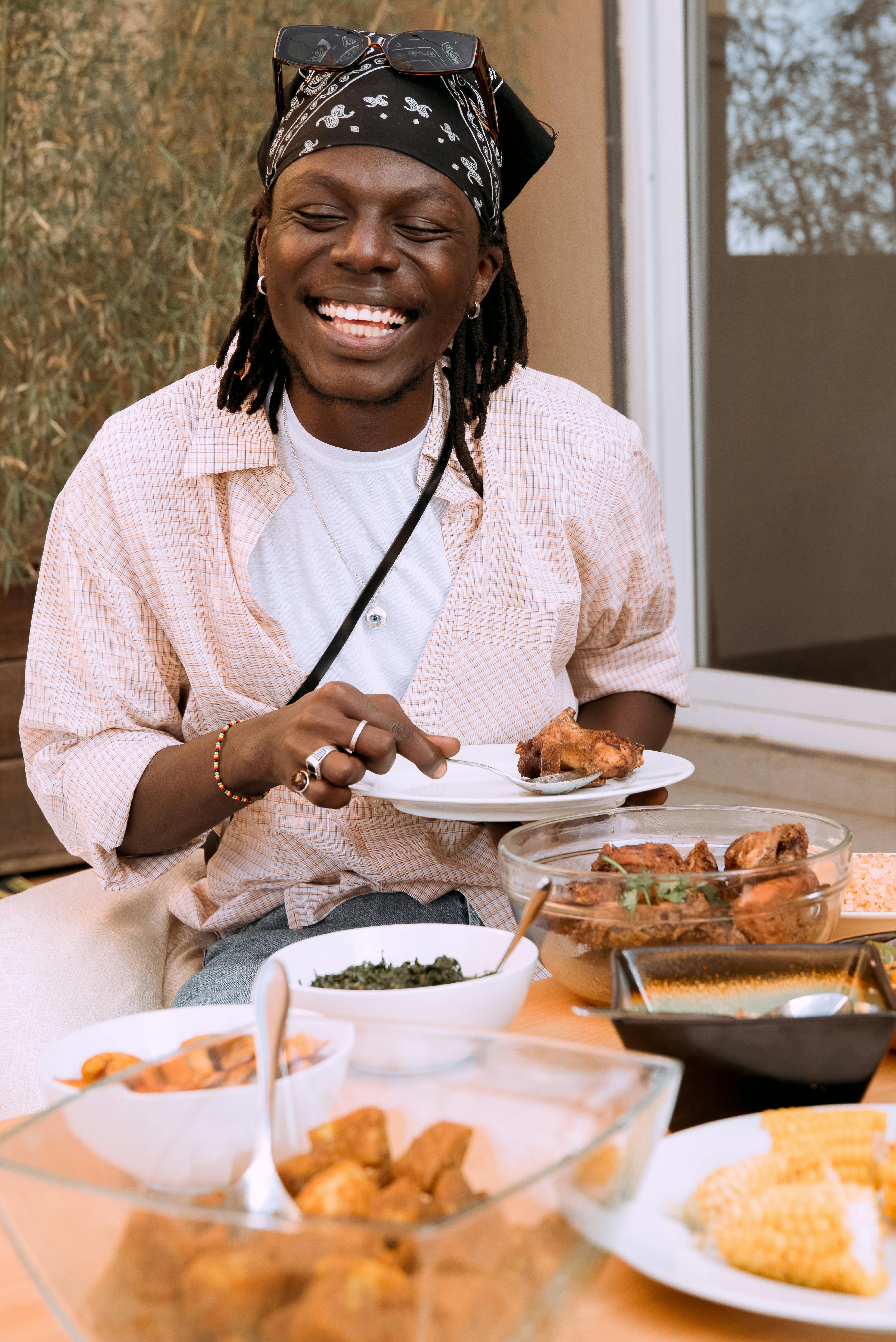 Man Putting Food on His Plate and Smiling · Free Stock Photo