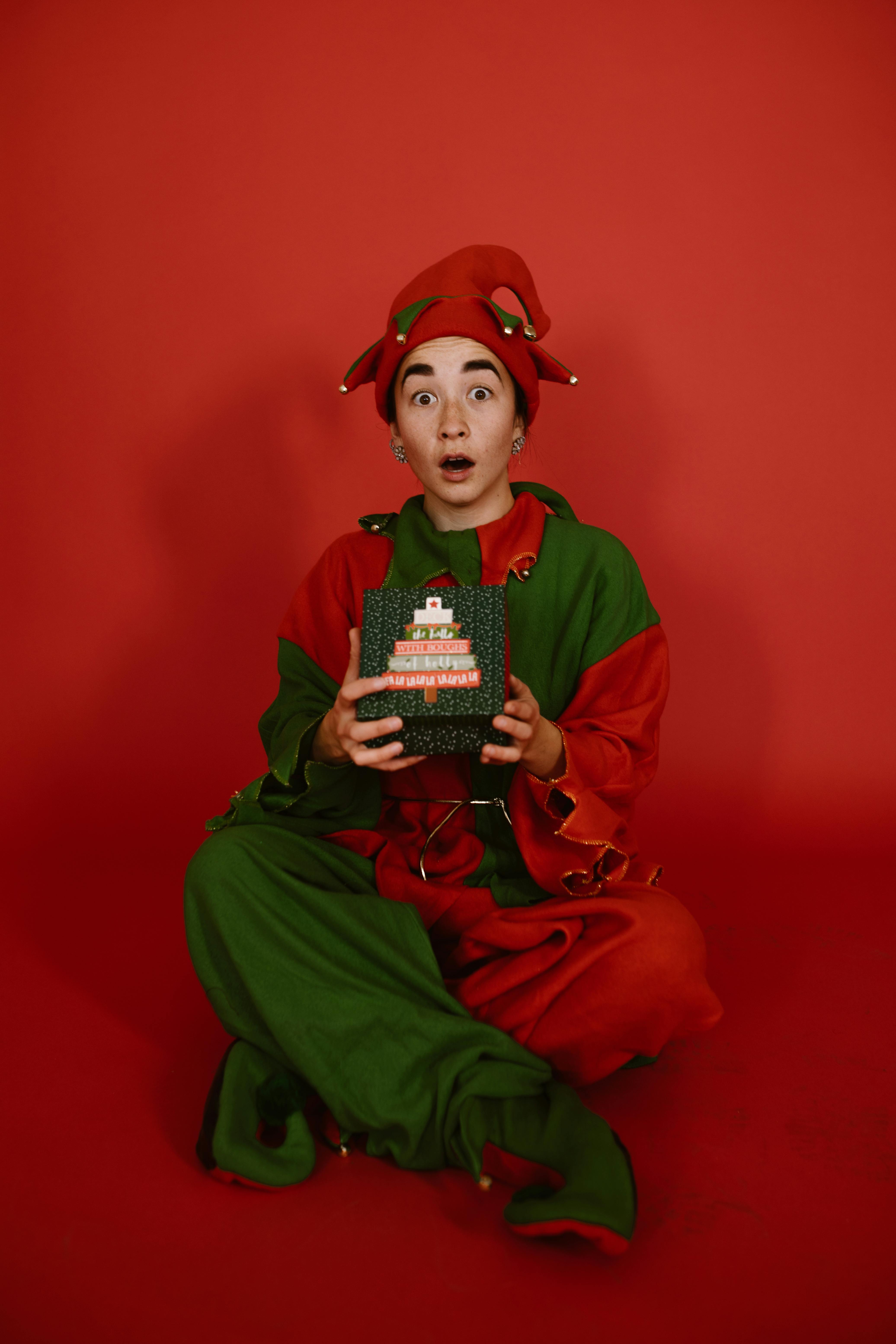 A Shocked Elf Holding a Present · Free Stock Photo