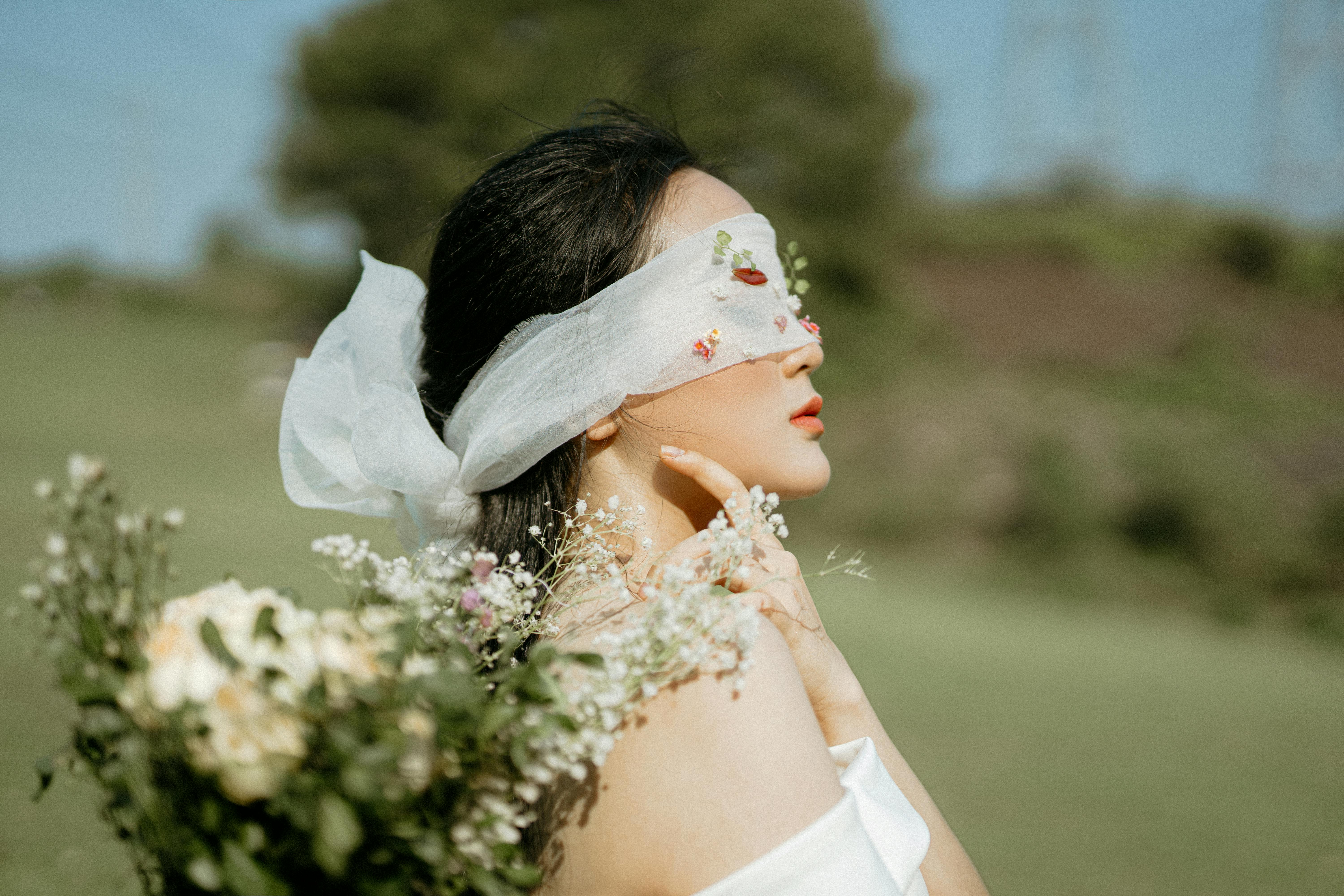 Faceless Asian woman covering eyes with veil in nature · Free Stock Photo
