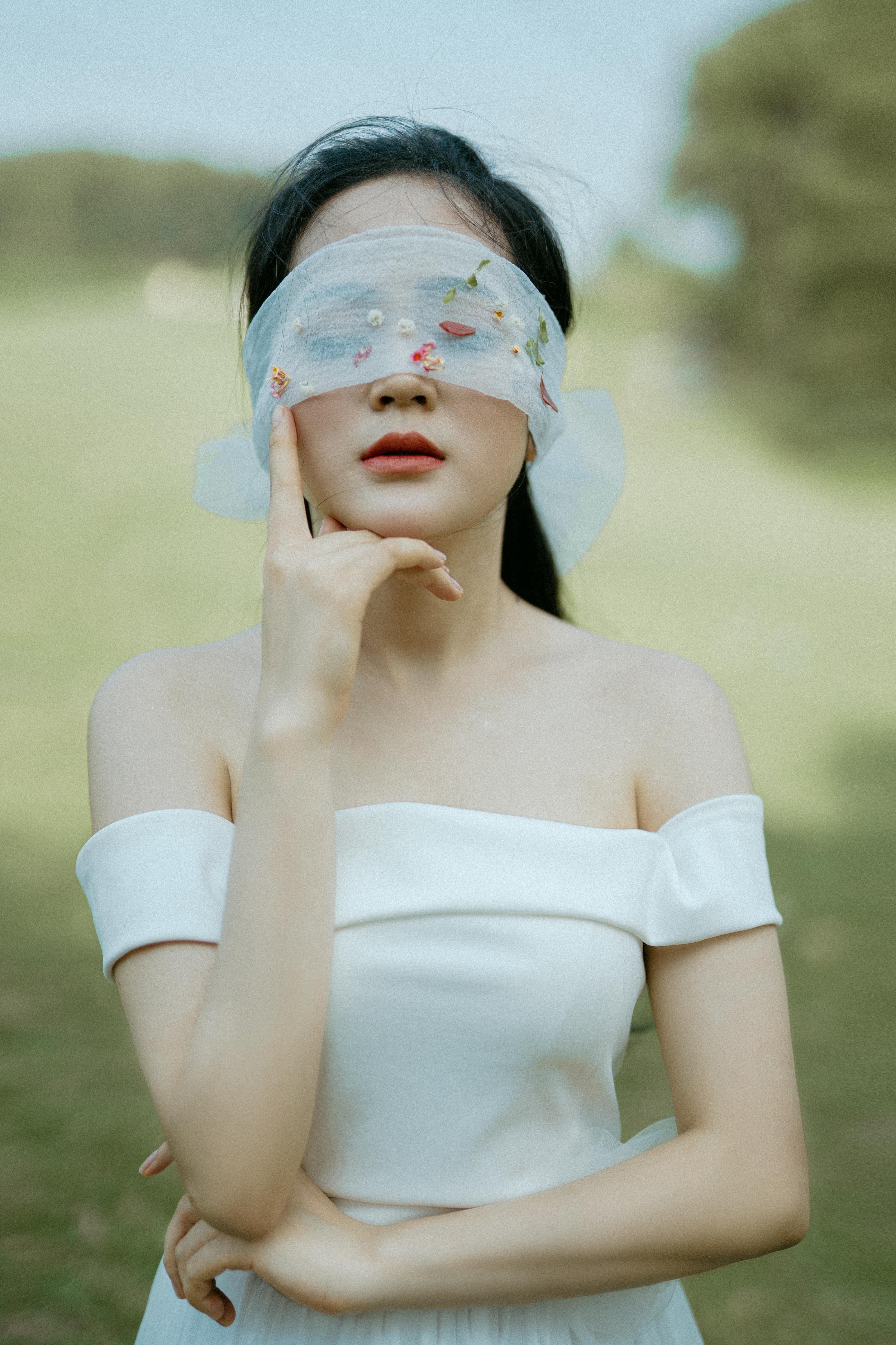 Faceless ethnic woman covering eyes with veil in countryside · Free ...