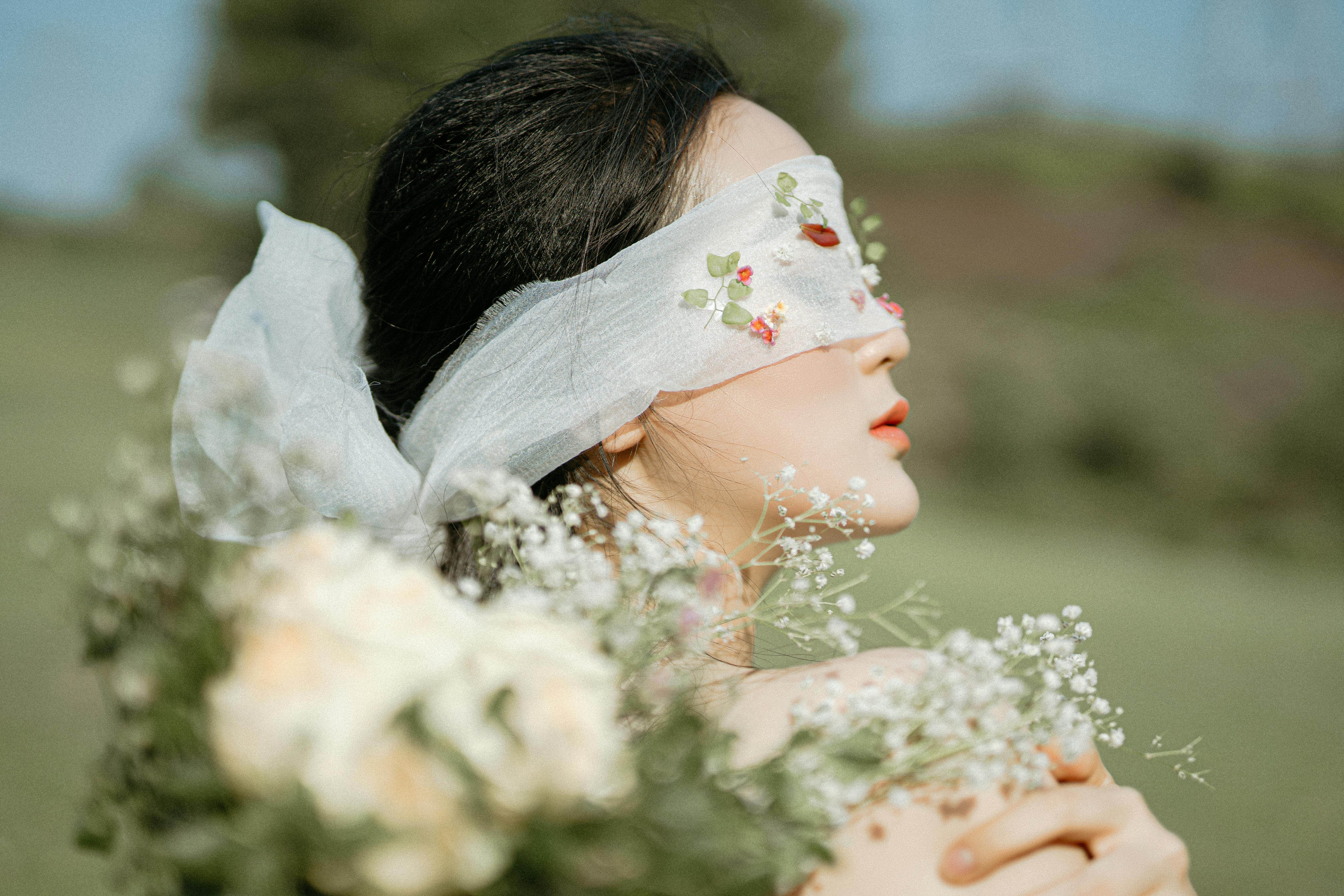 Faceless ethnic woman covering eyes with veil in nature · Free Stock Photo