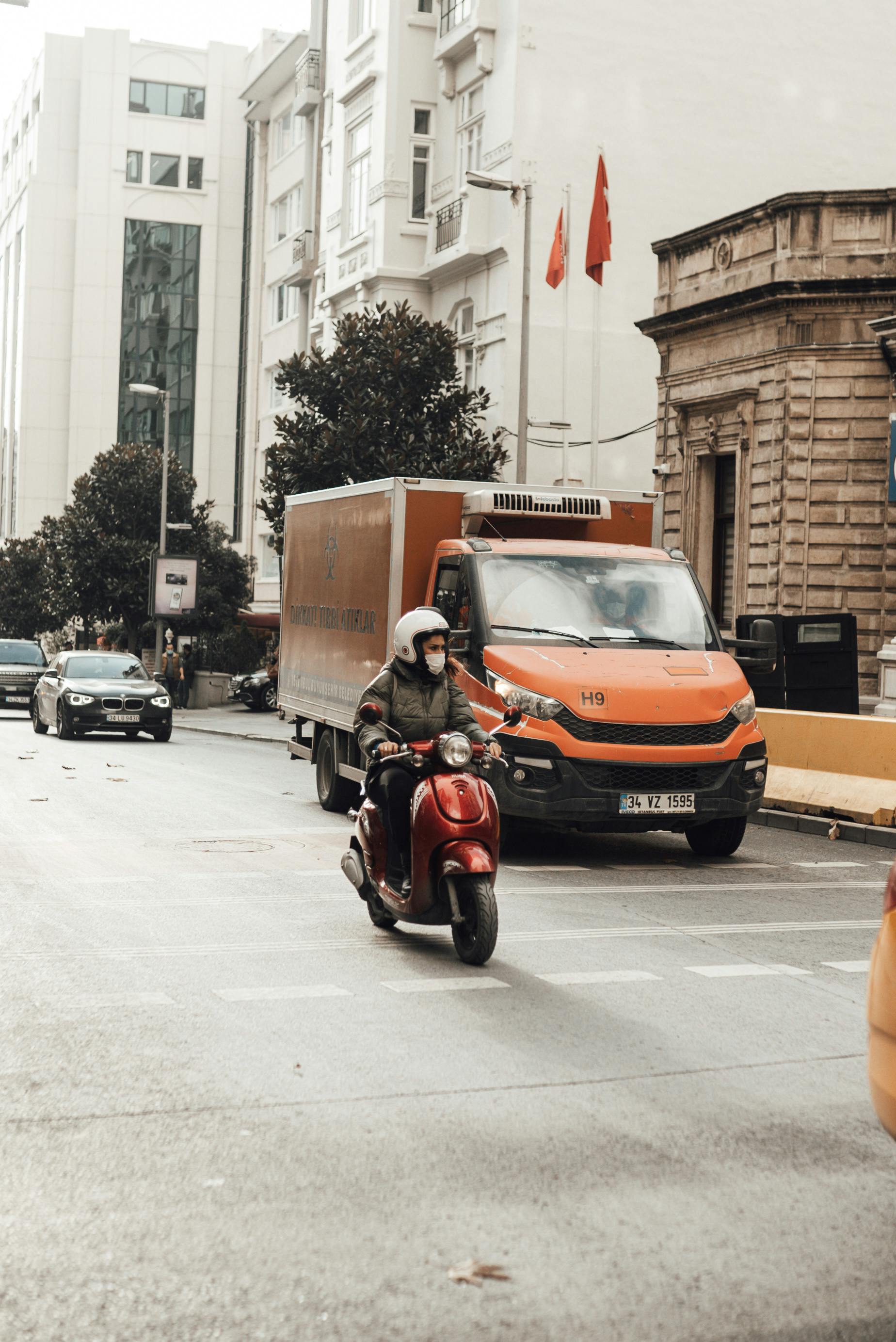 Rider on motorbike riding on road with cars · Free Stock Photo