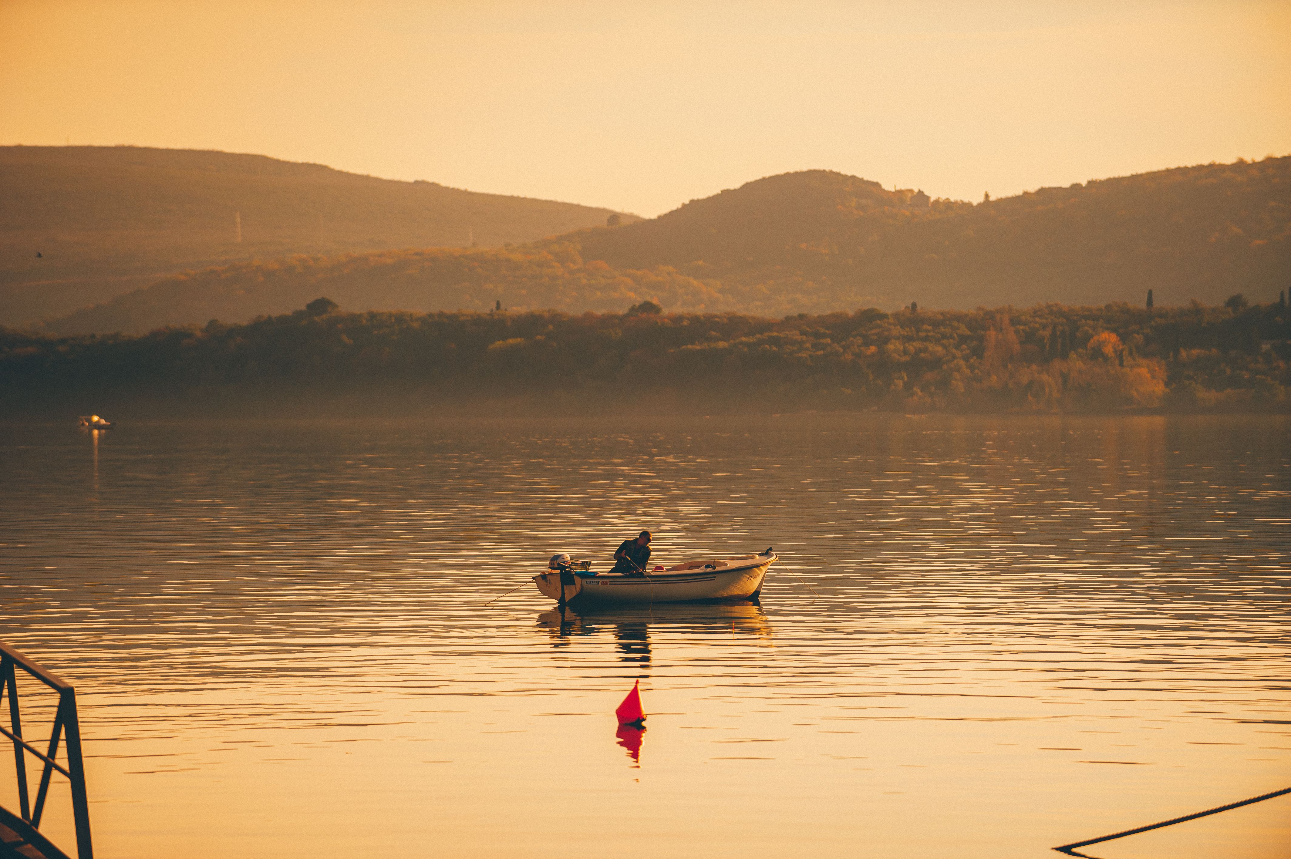 A Person Riding on the Boat on the Lake · Free Stock Photo