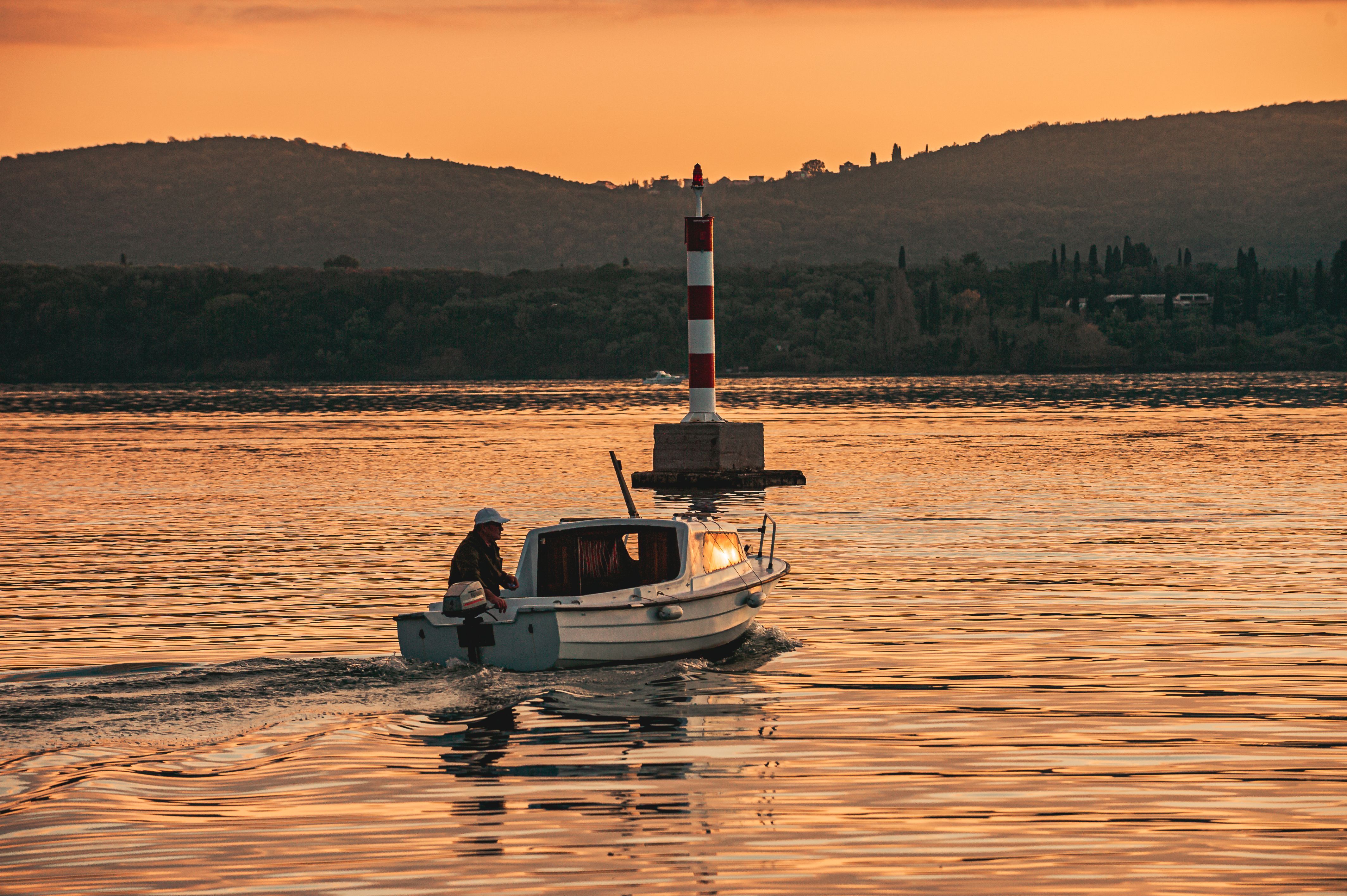 A Person Riding on a Speedboat during Sunset · Free Stock Photo