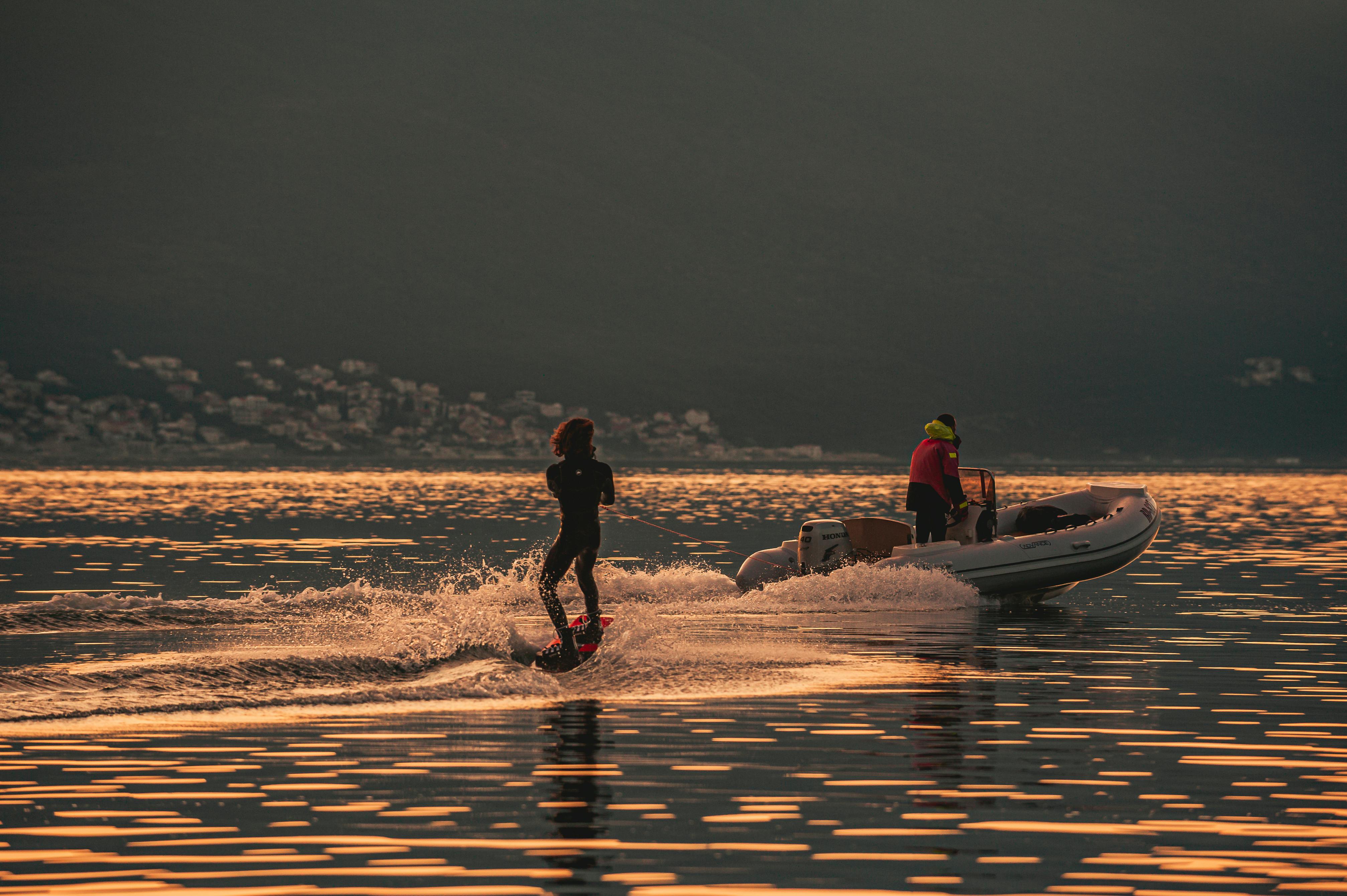 Person Wakeboarding in Sea at Sunset · Free Stock Photo