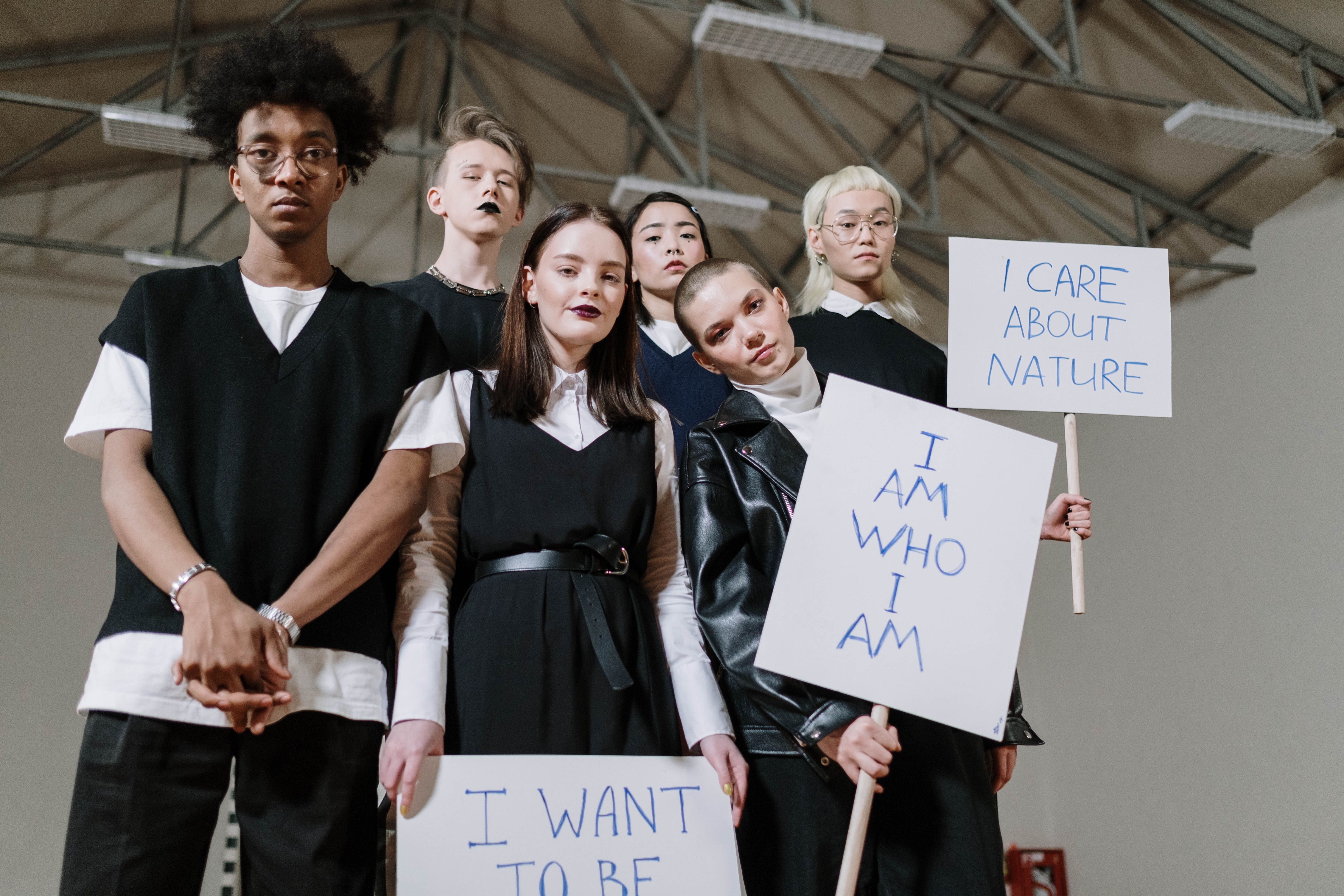A Group of Students Standing in the Gym while Holding Placards · Free ...