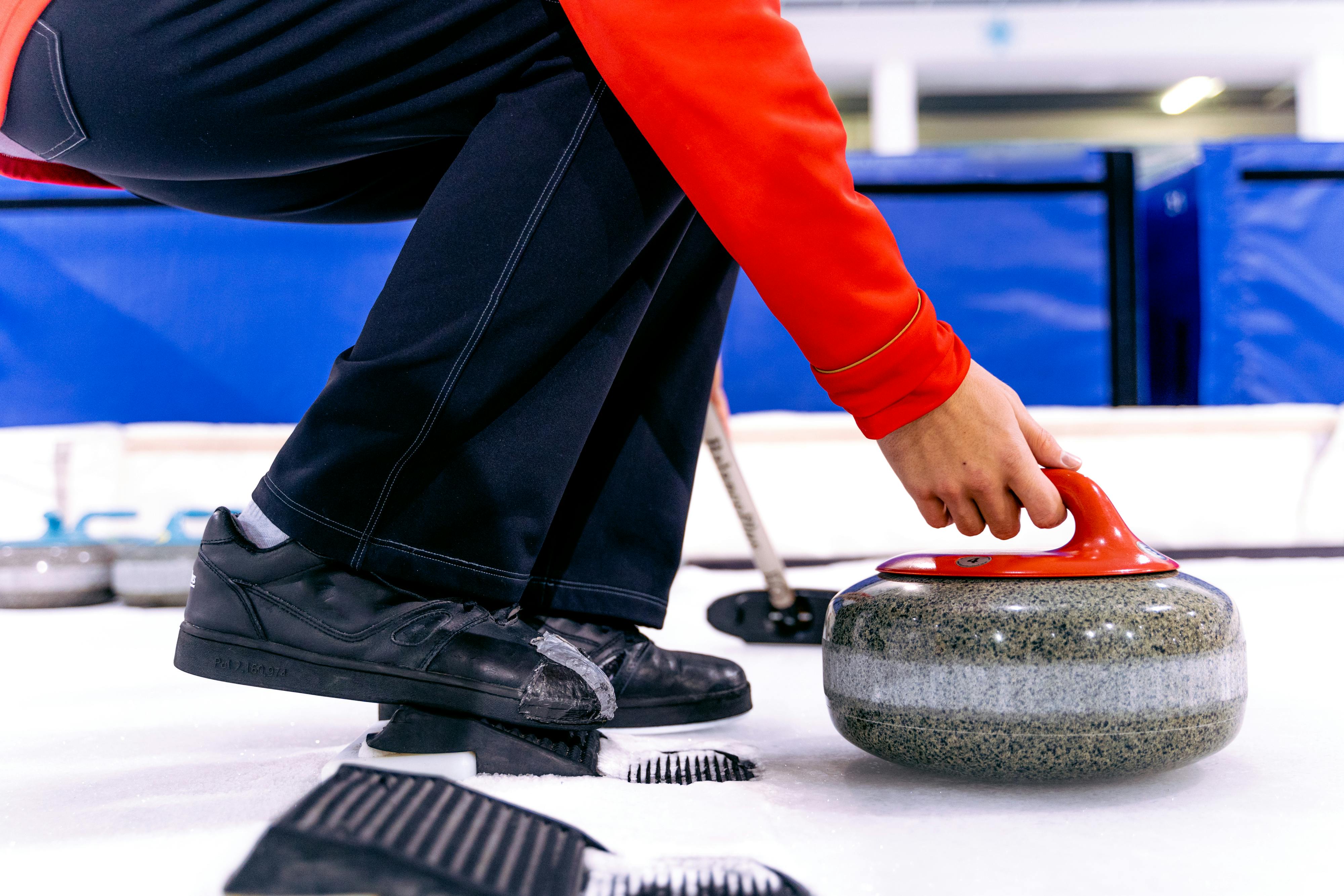 A Person Holding a Curling Stone · Free Stock Photo