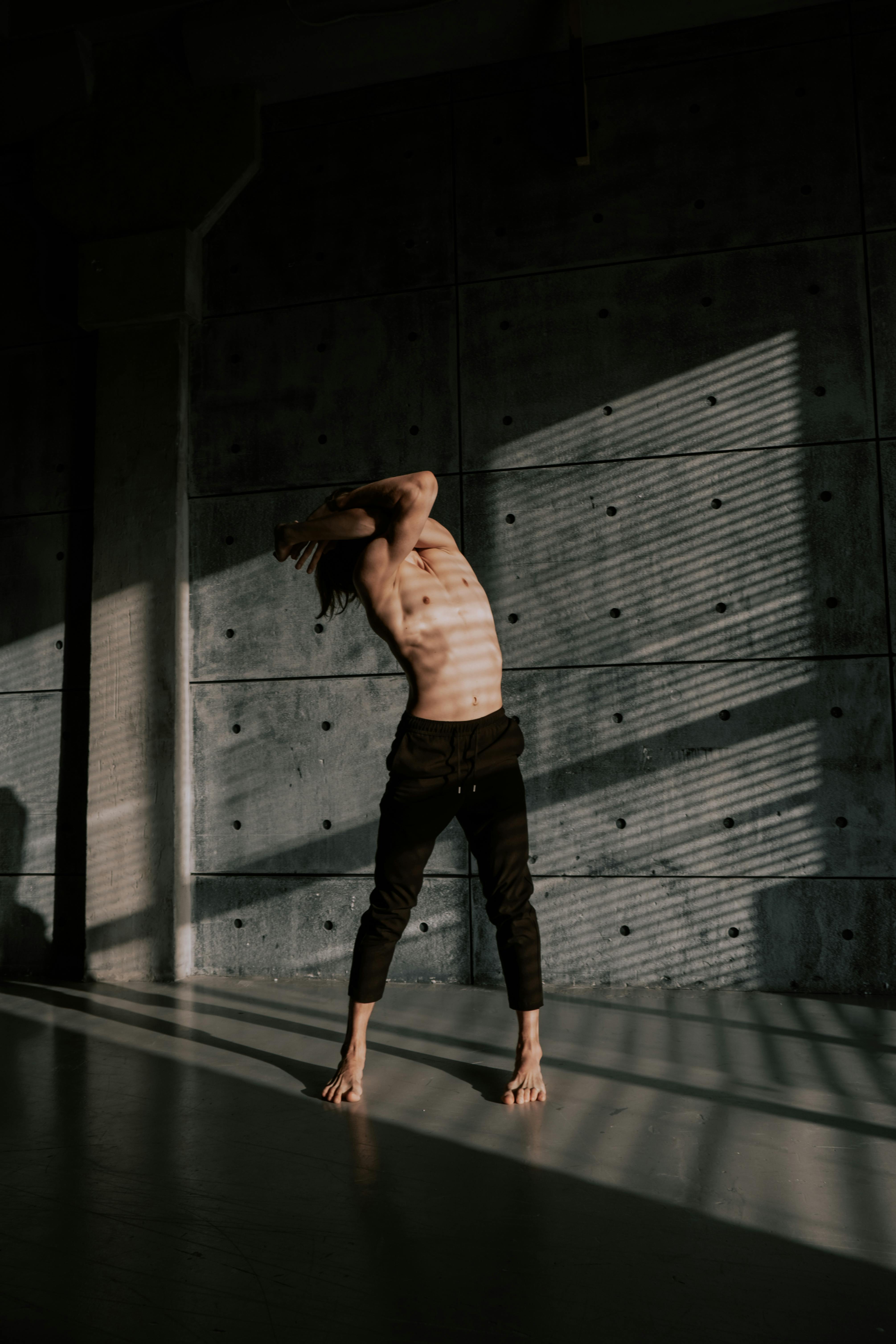 A Shirtless Man Dancing Gracefully · Free Stock Photo