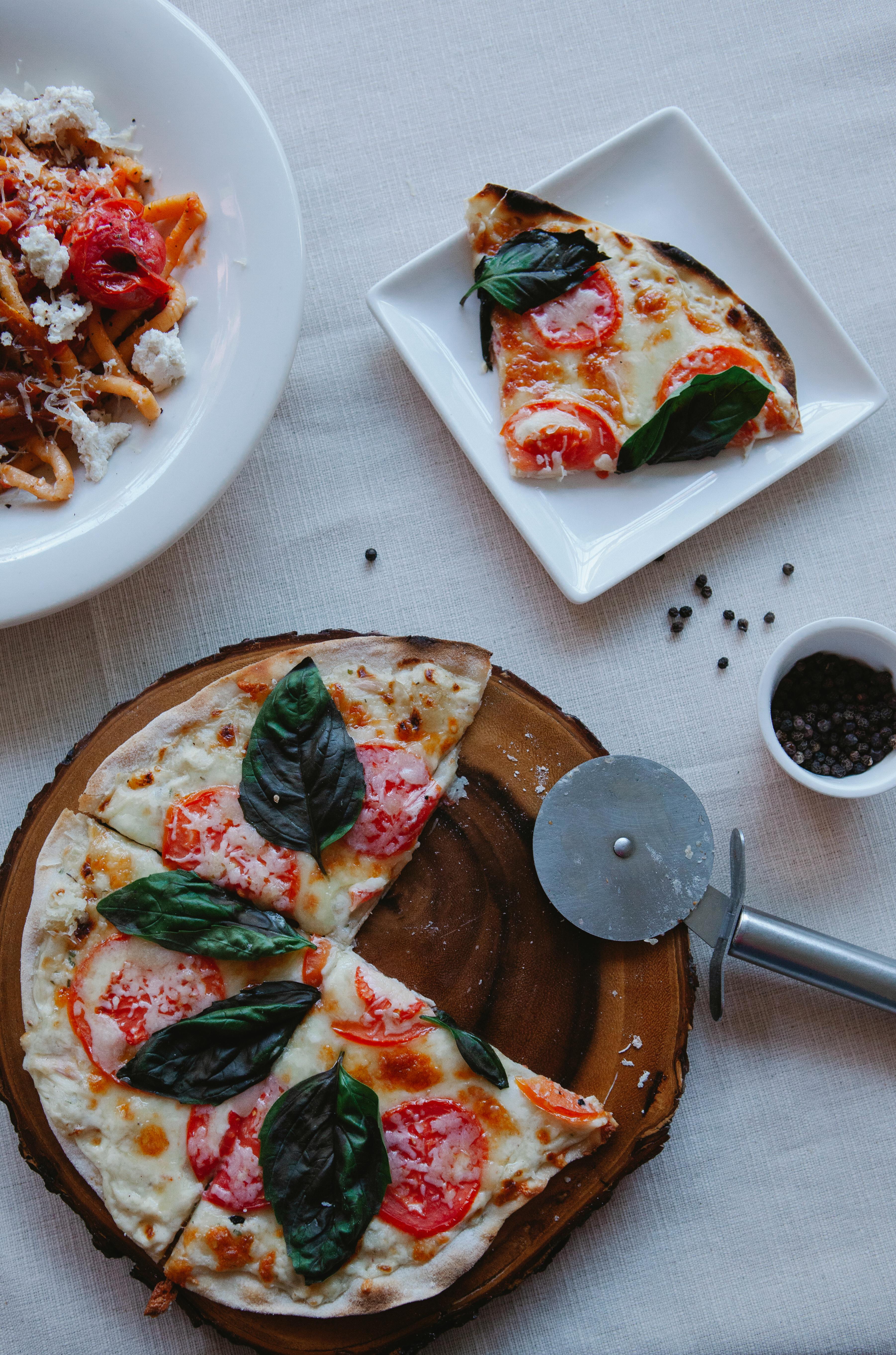 Pizza on Tray and Plates · Free Stock Photo