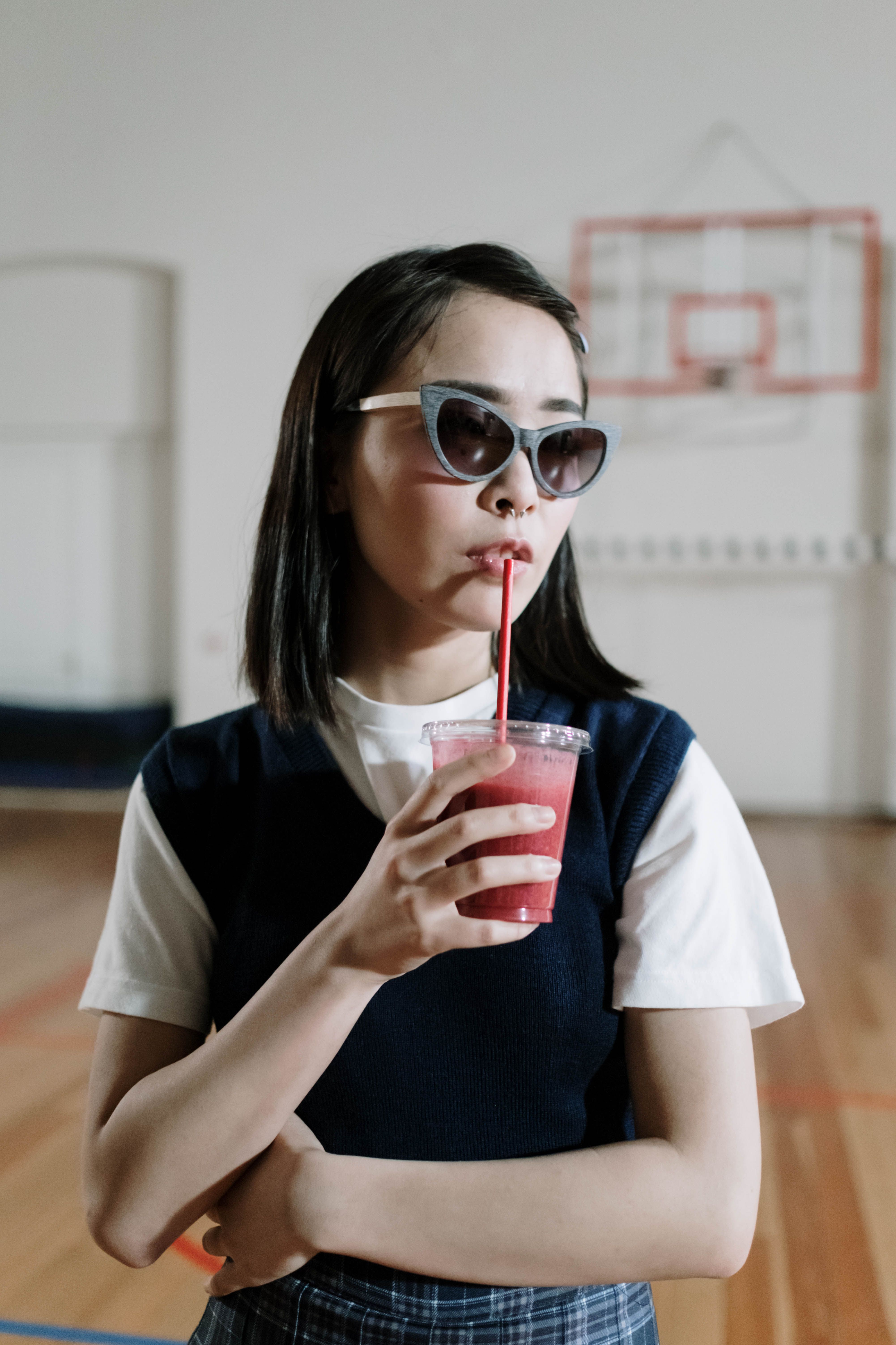 Schoolgirl Drinking Soda at School Gym · Free Stock Photo