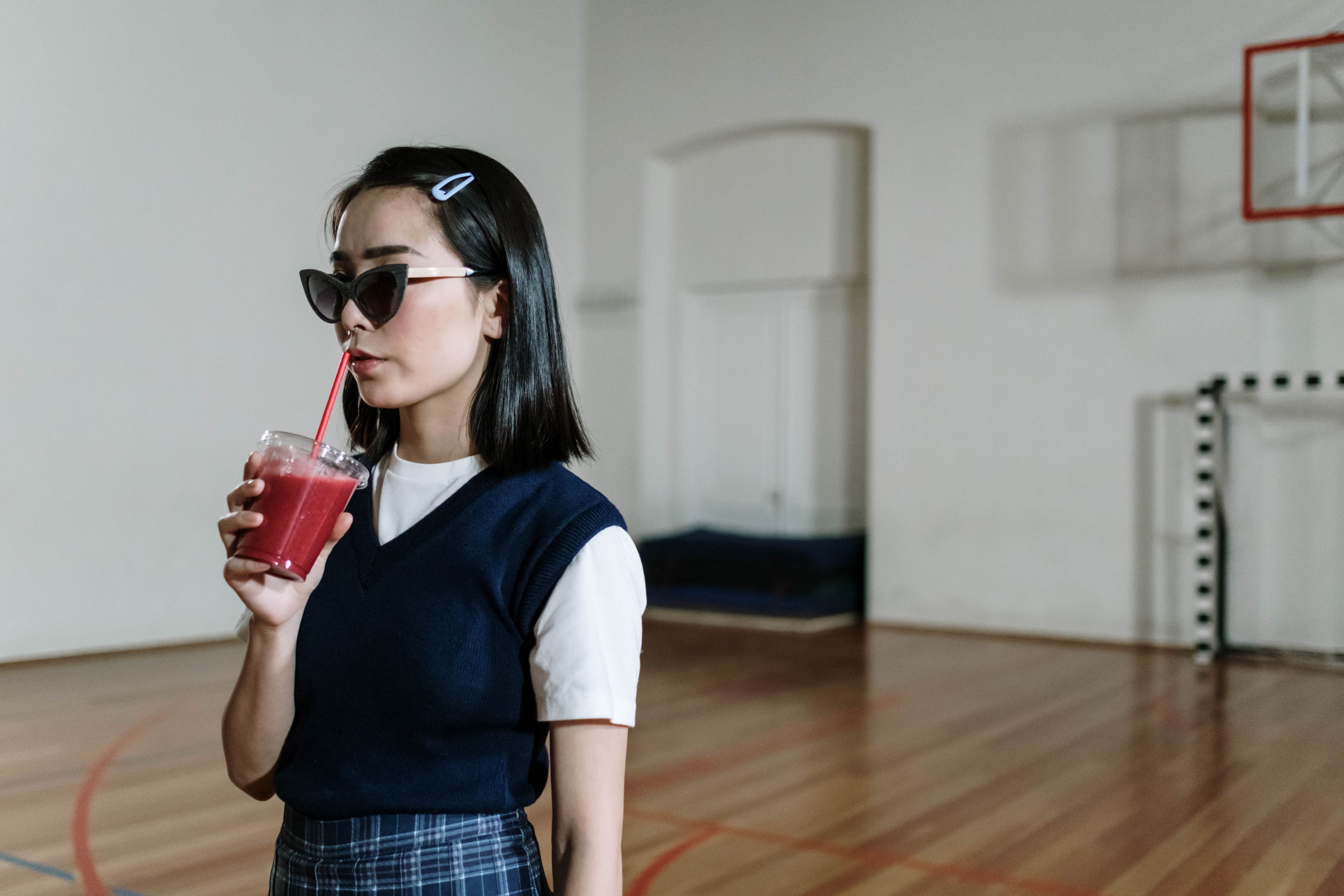 Schoolgirl Drinking Soda at School Gym · Free Stock Photo