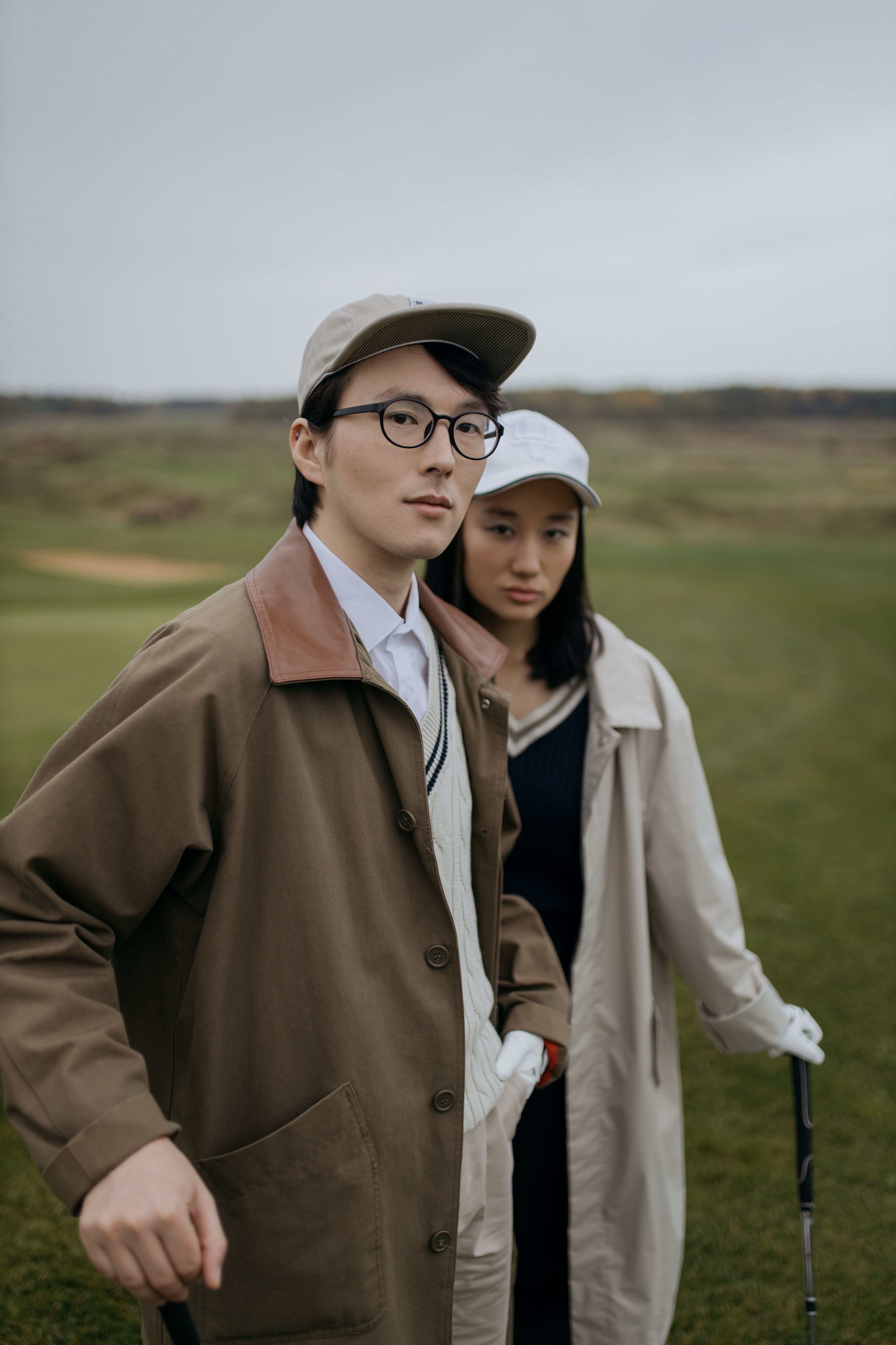 Couple Wearing Coats Standing on a Field · Free Stock Photo