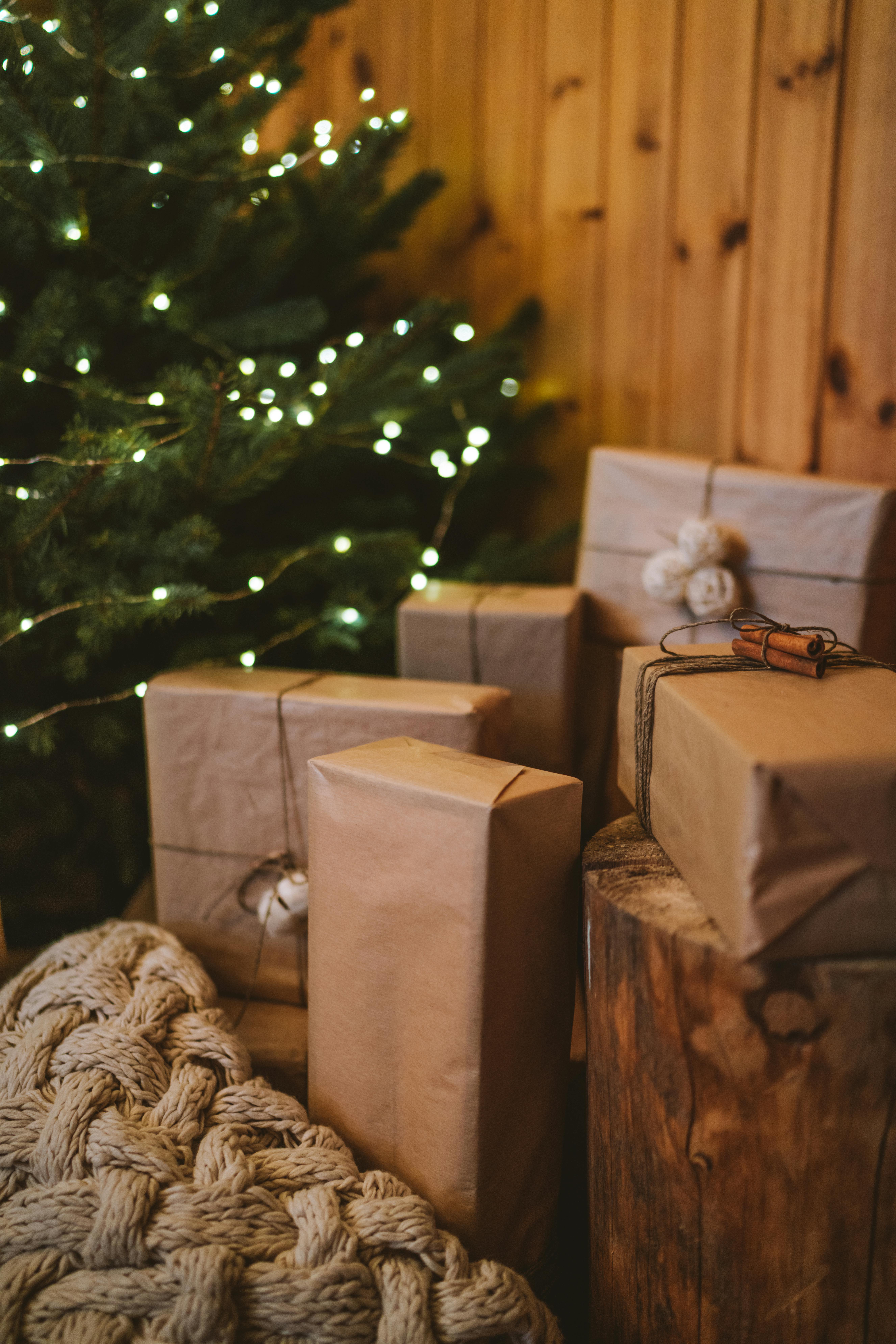 Brown Gift Boxes Beside a Christmas Tree · Free Stock Photo