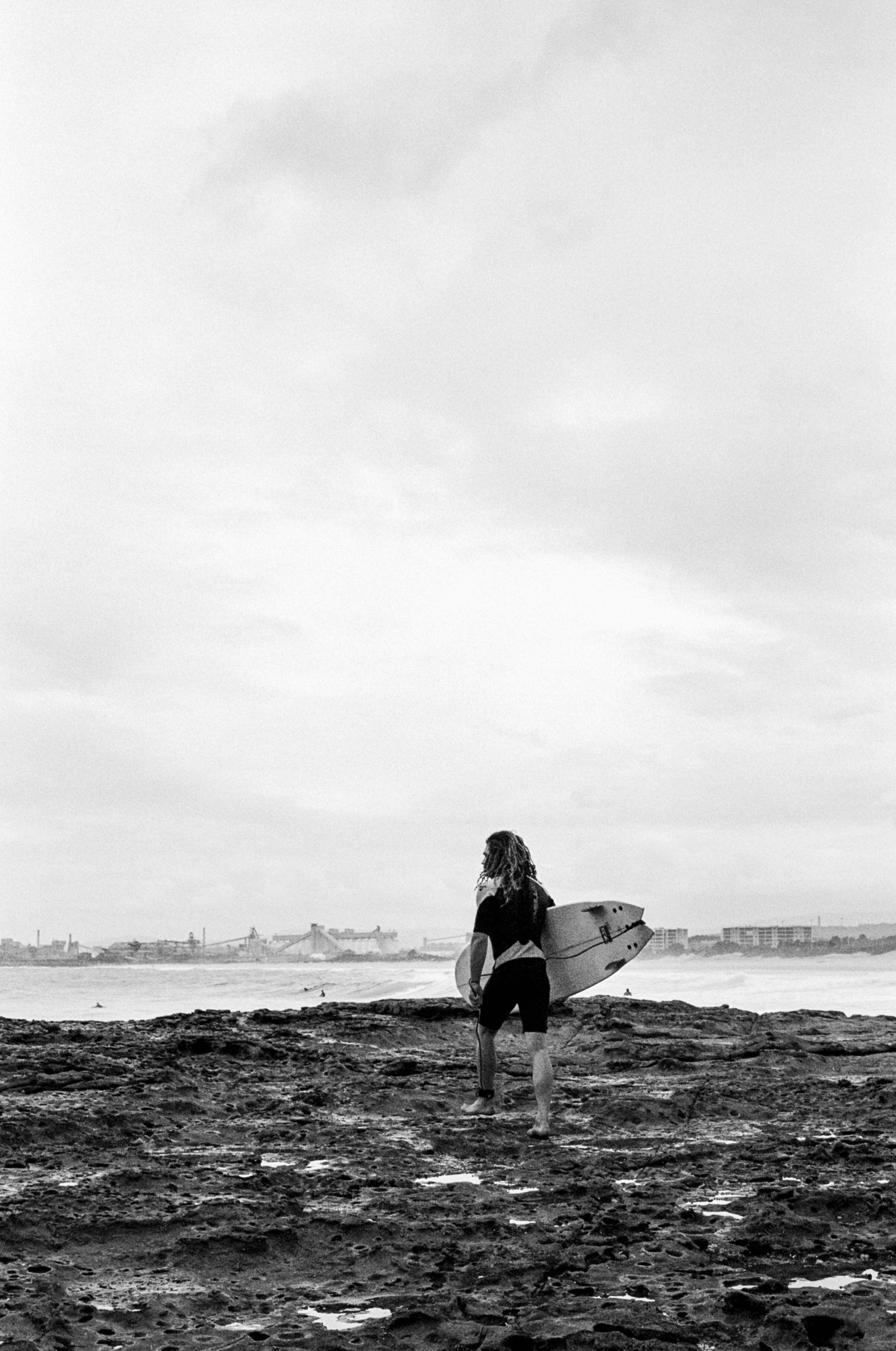 Person with Surfboard on Sea Shore · Free Stock Photo