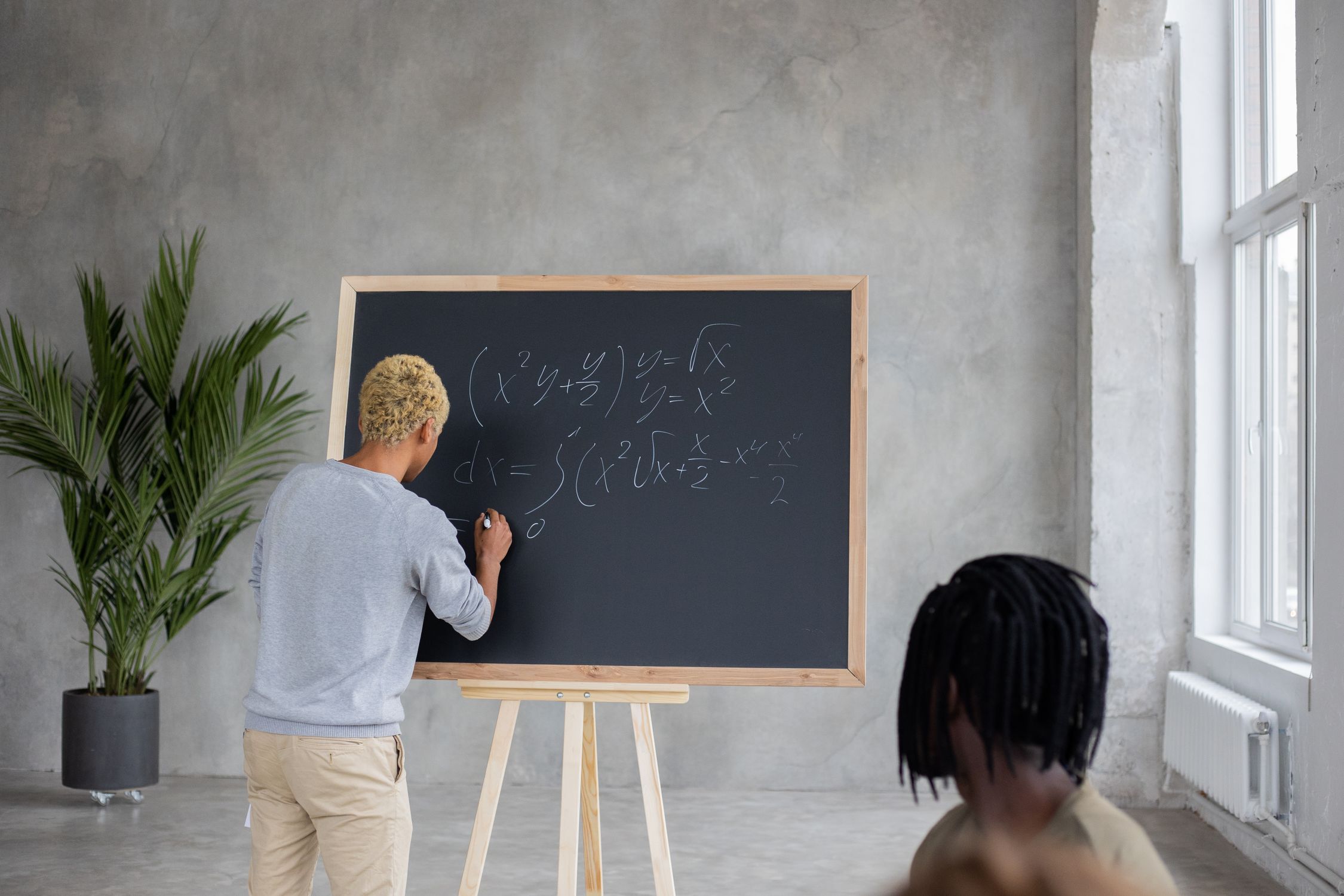 Anonymous Black Man Writing Equation On Chalkboard Free Stock Photo anonymous-black-man-writing-equation-on-chalkboard-free-stock-photo