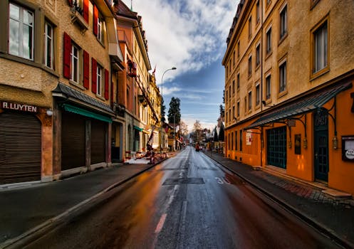 Black Asphalt Road Between Brown City Building Under White Skies during ...