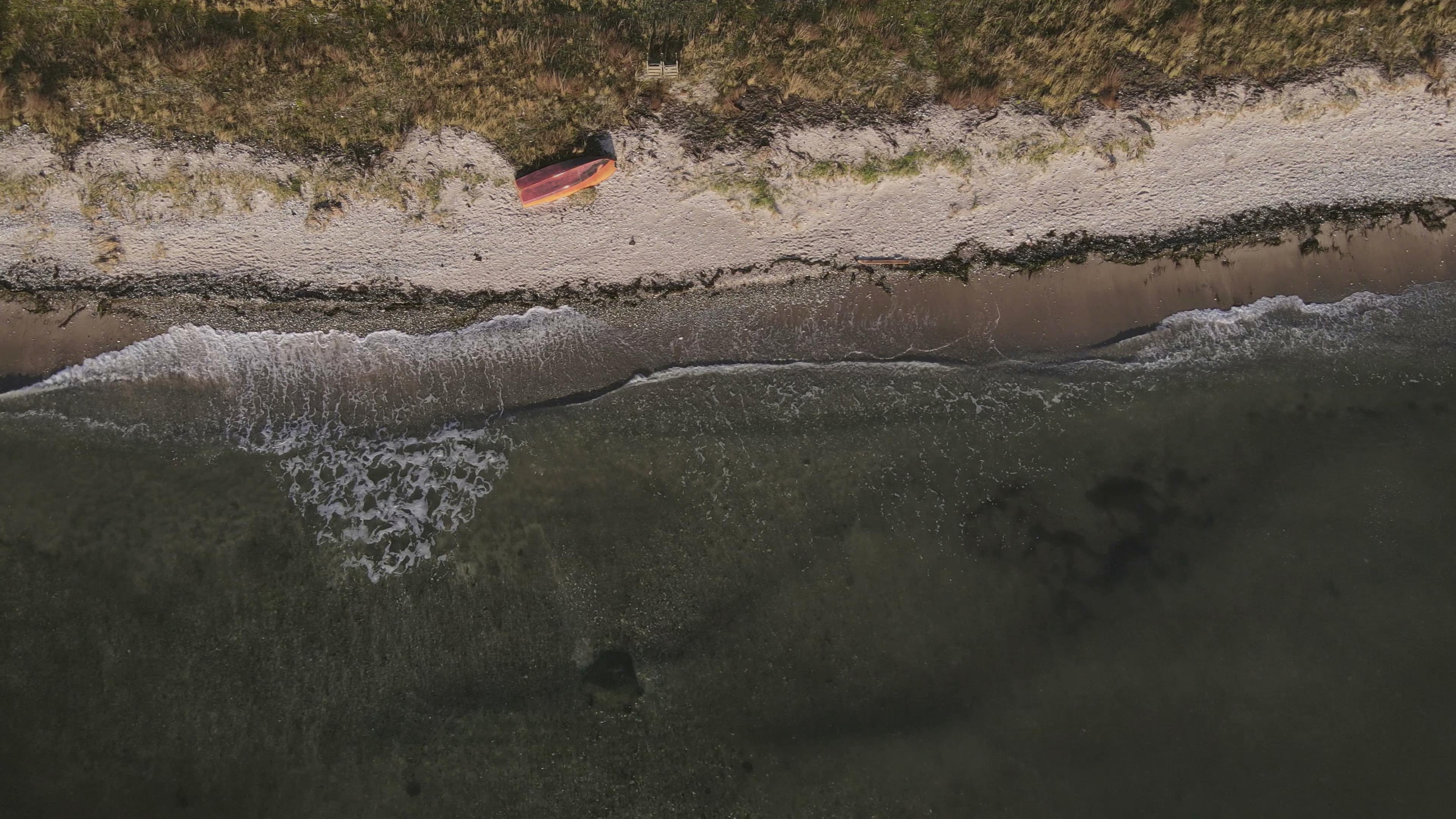Drone Shot of a Beach with a Boat on the Sand · Free Stock Photo