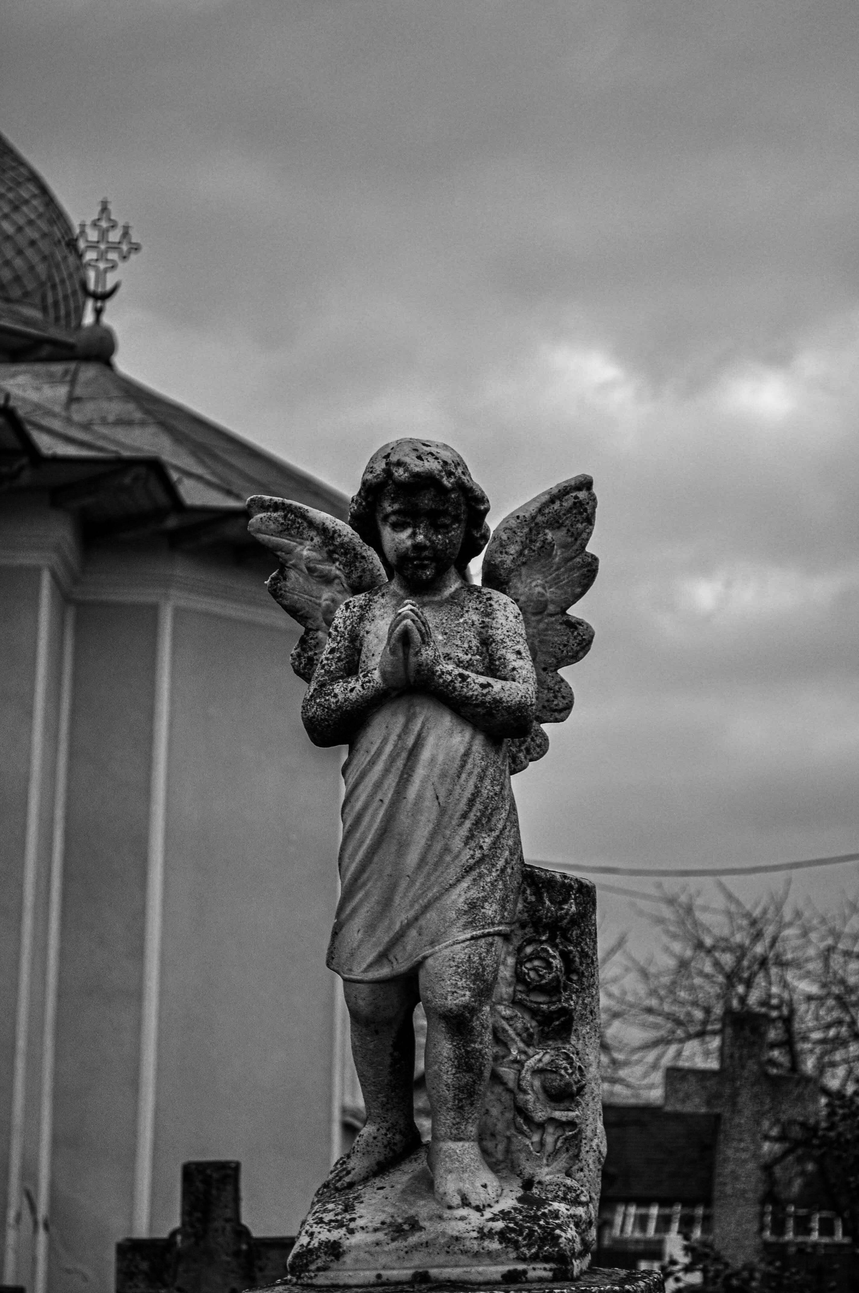 Monochrome Photo of an Angel Sculpture Praying · Free Stock Photo