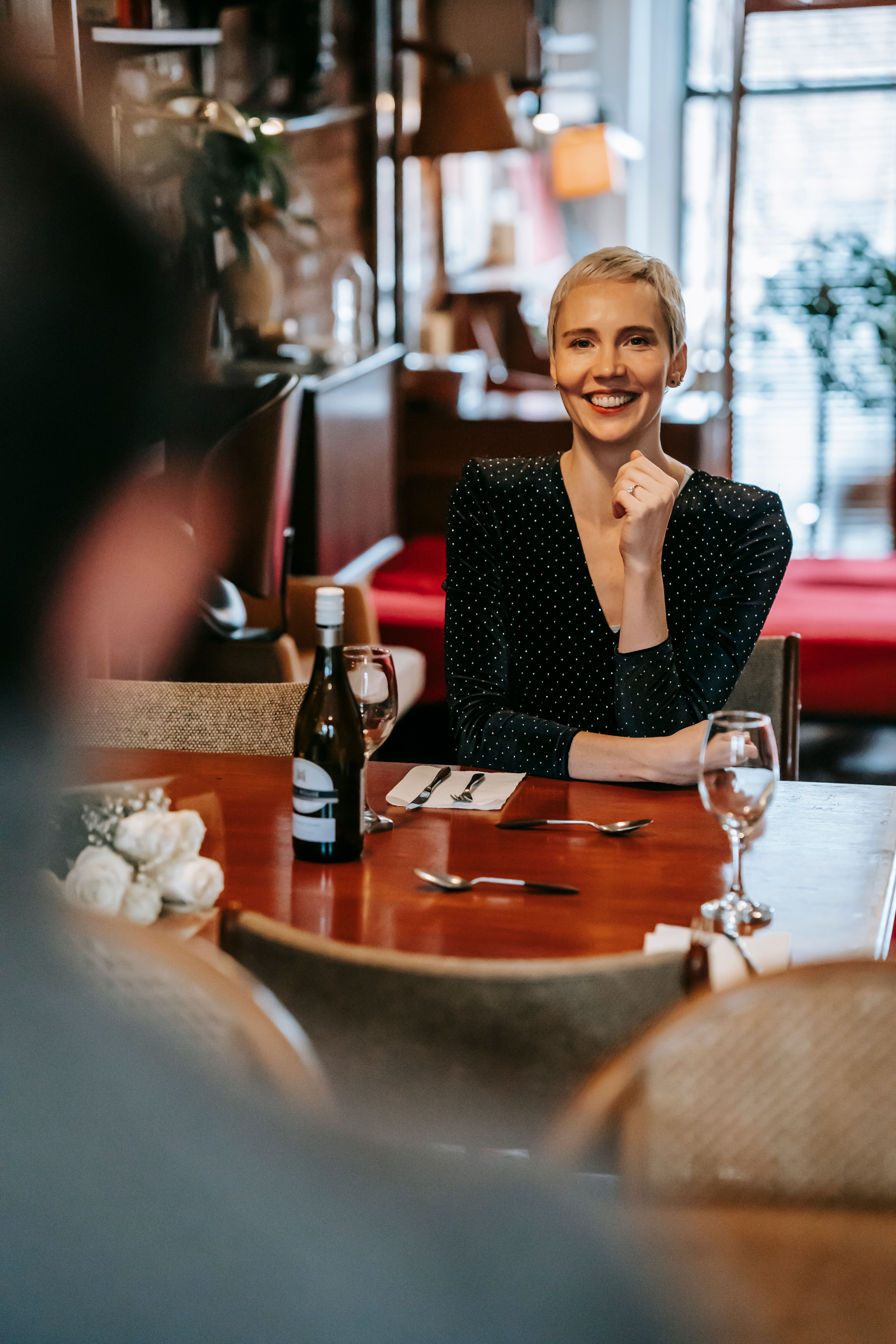 Male near counter having date with female at table · Free Stock Photo