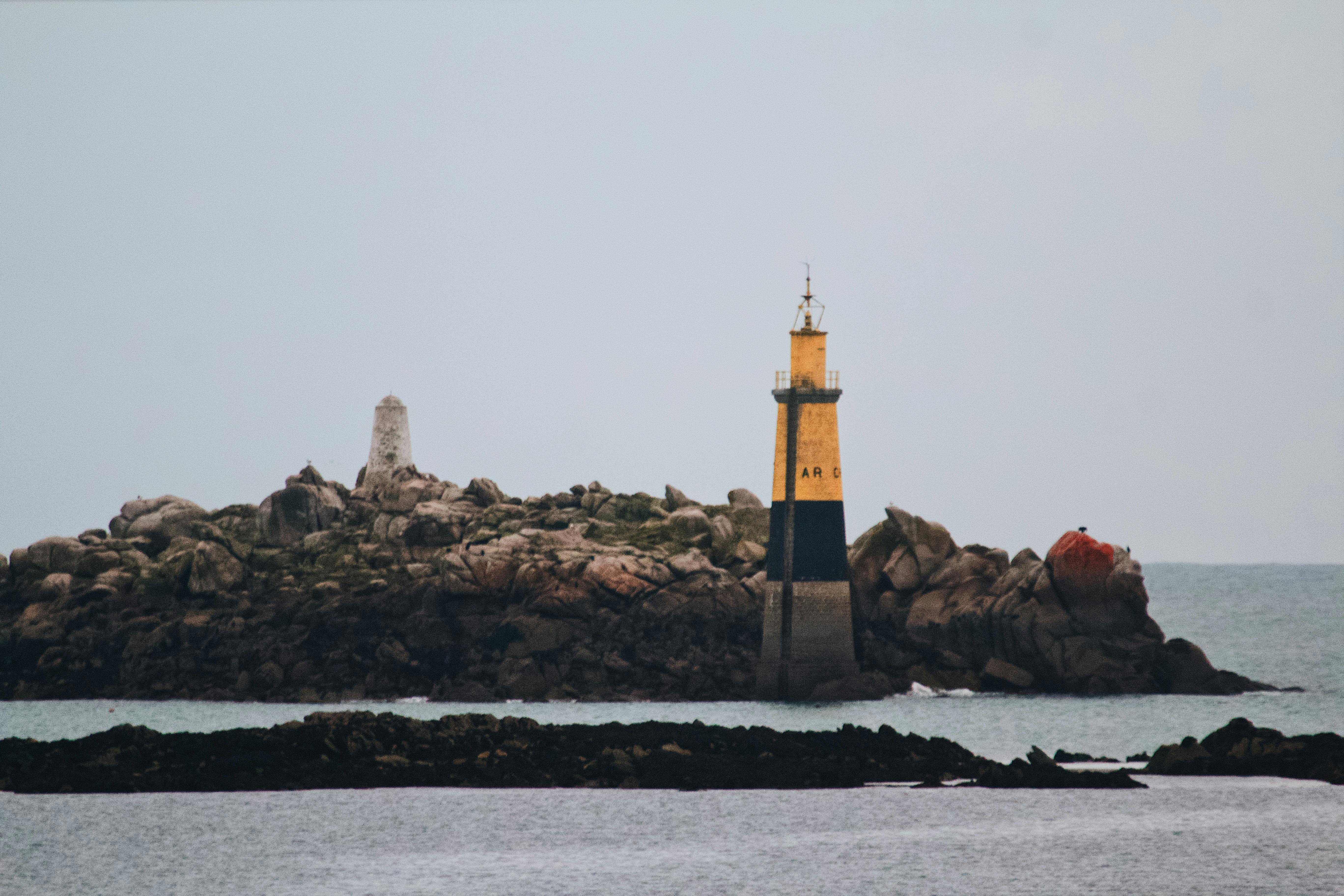 Lighthouse on an Island in a Sea · Free Stock Photo