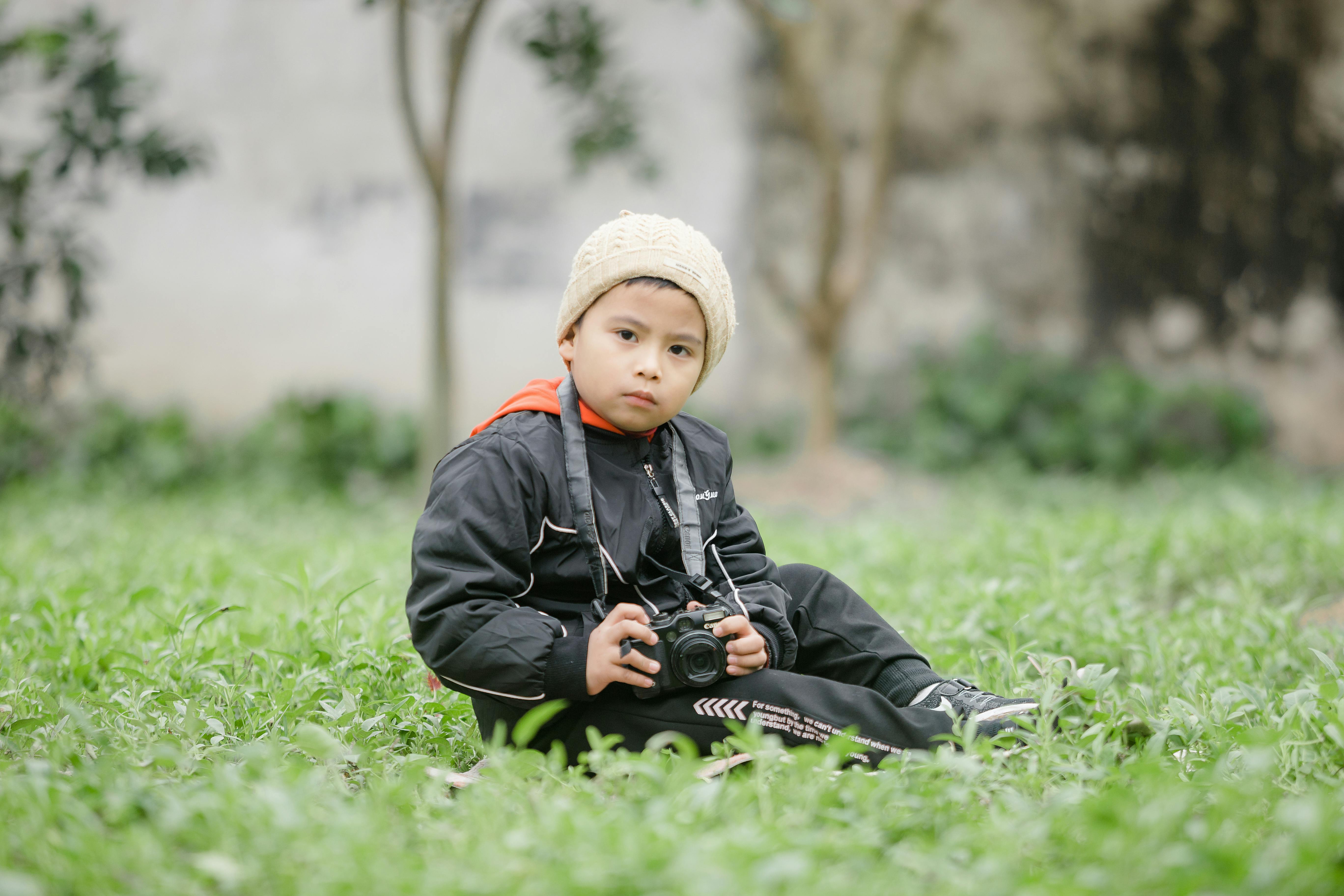 Photo of a Child in a Brown Puffer Jacket Holding a Lit Candle · Free ...