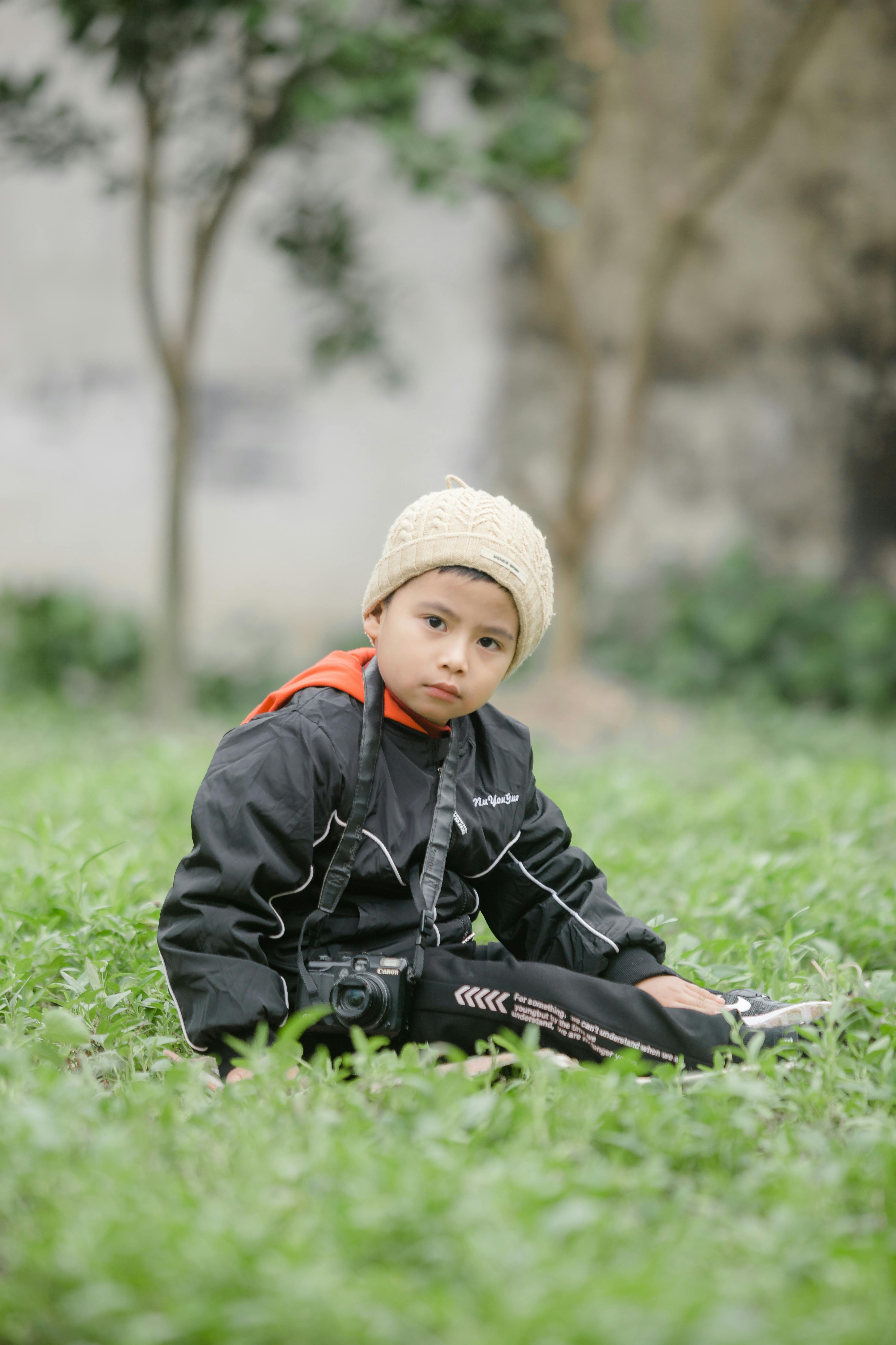 Photo of a Child in a Brown Puffer Jacket Holding a Lit Candle · Free ...