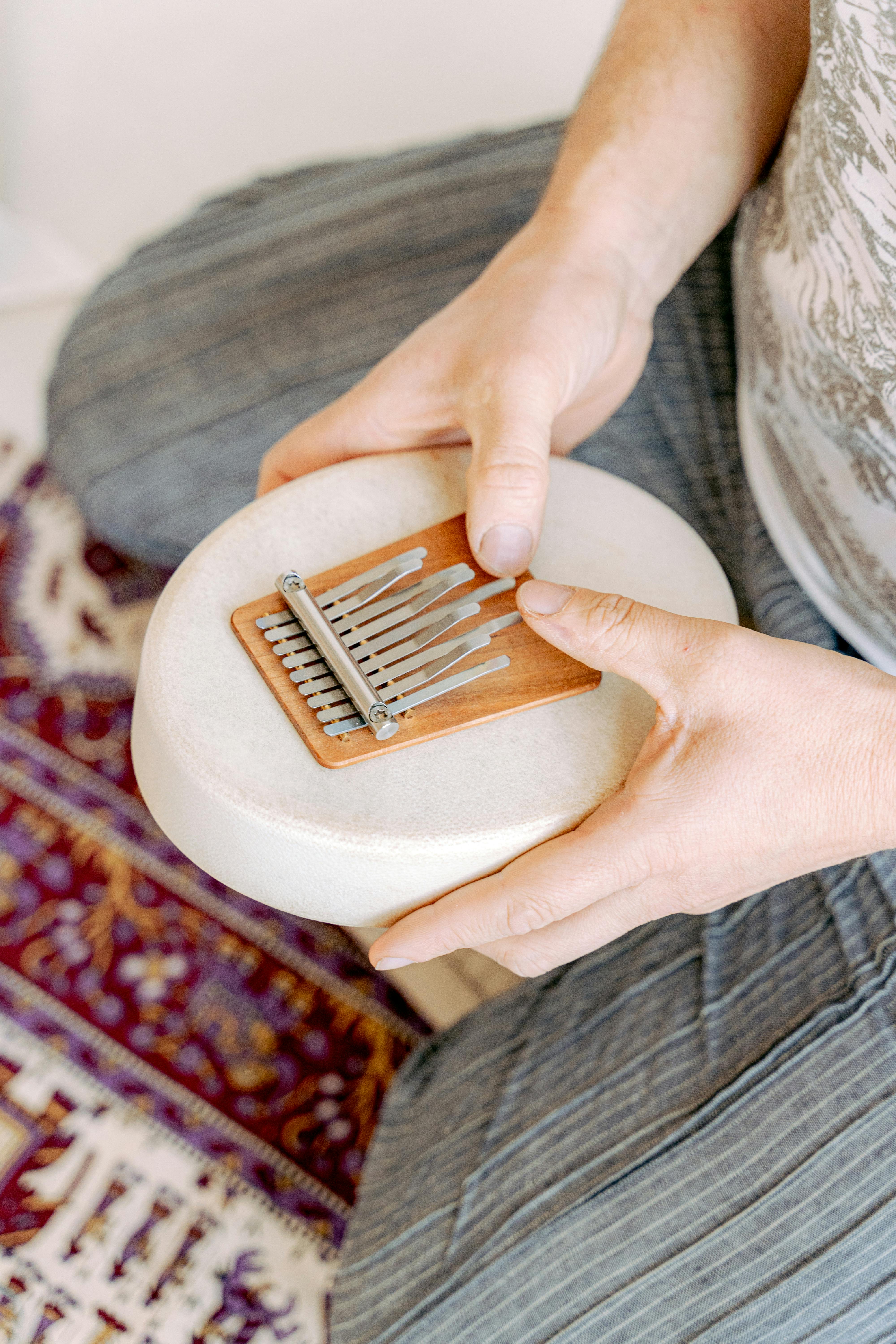 Photo of a Person's Hands Using a Kalimba · Free Stock Photo