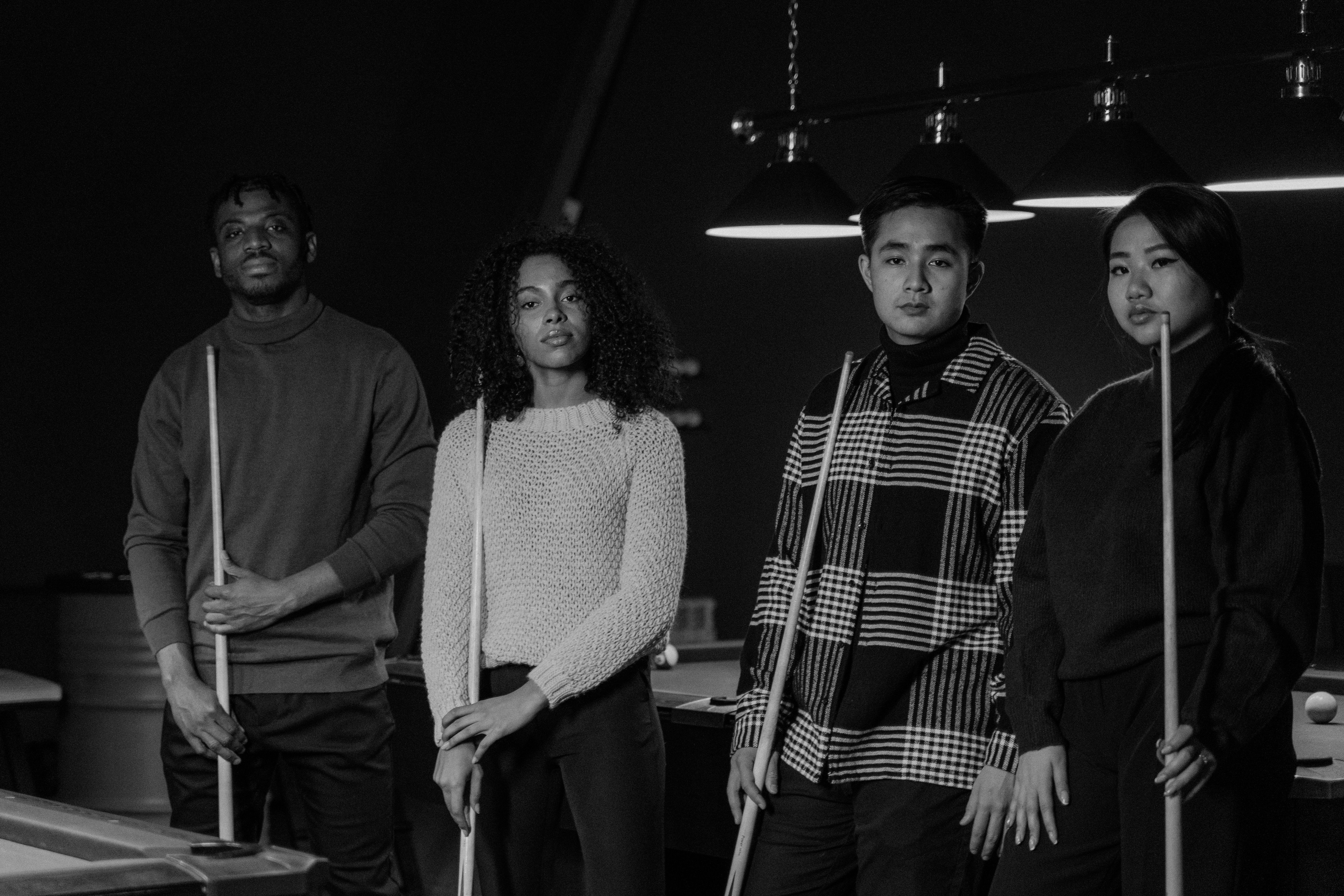Grayscale Photograph of People Holding Cue Sticks · Free Stock Photo