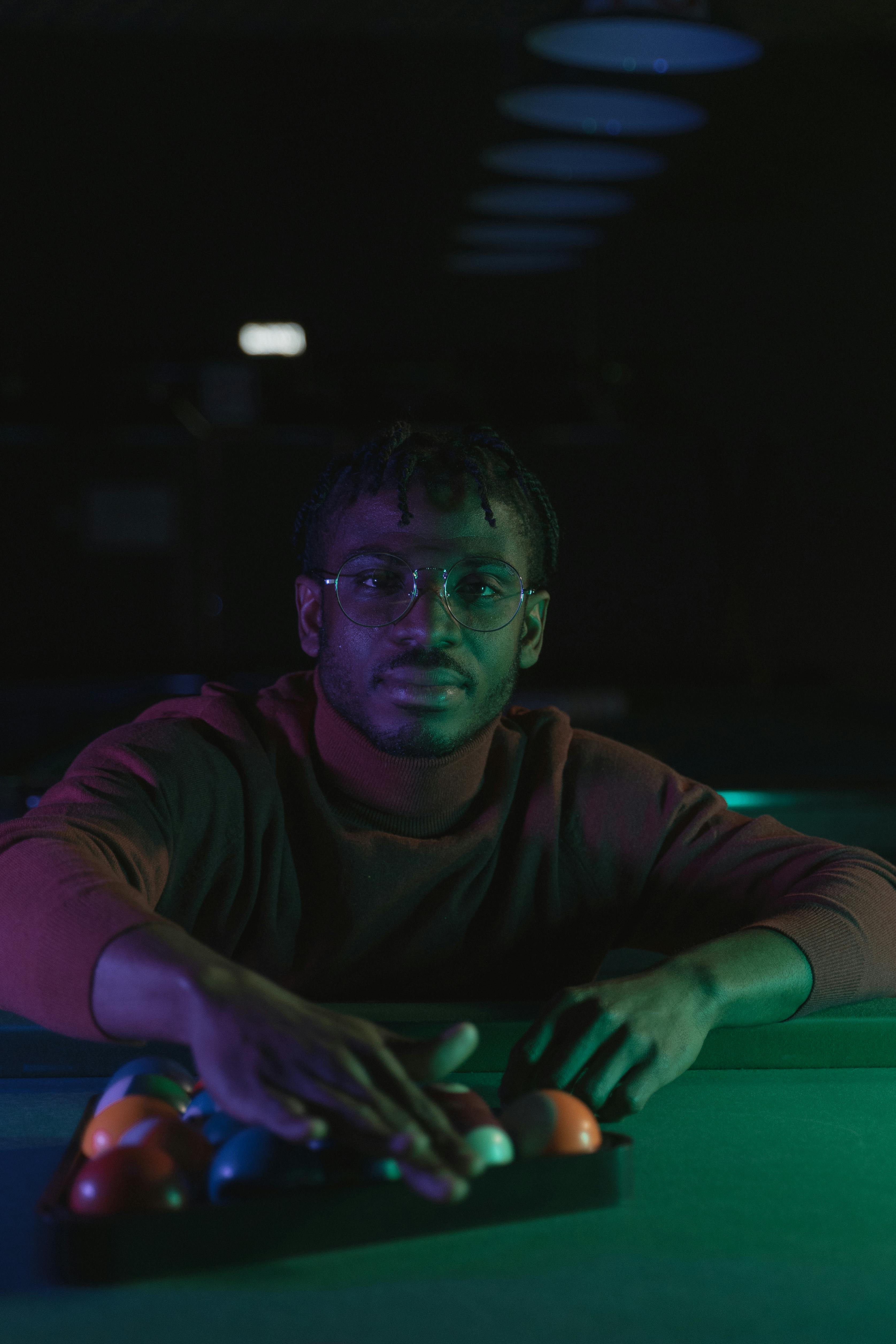 A Man With Eyeglasses Touching the Billiard Balls · Free Stock Photo